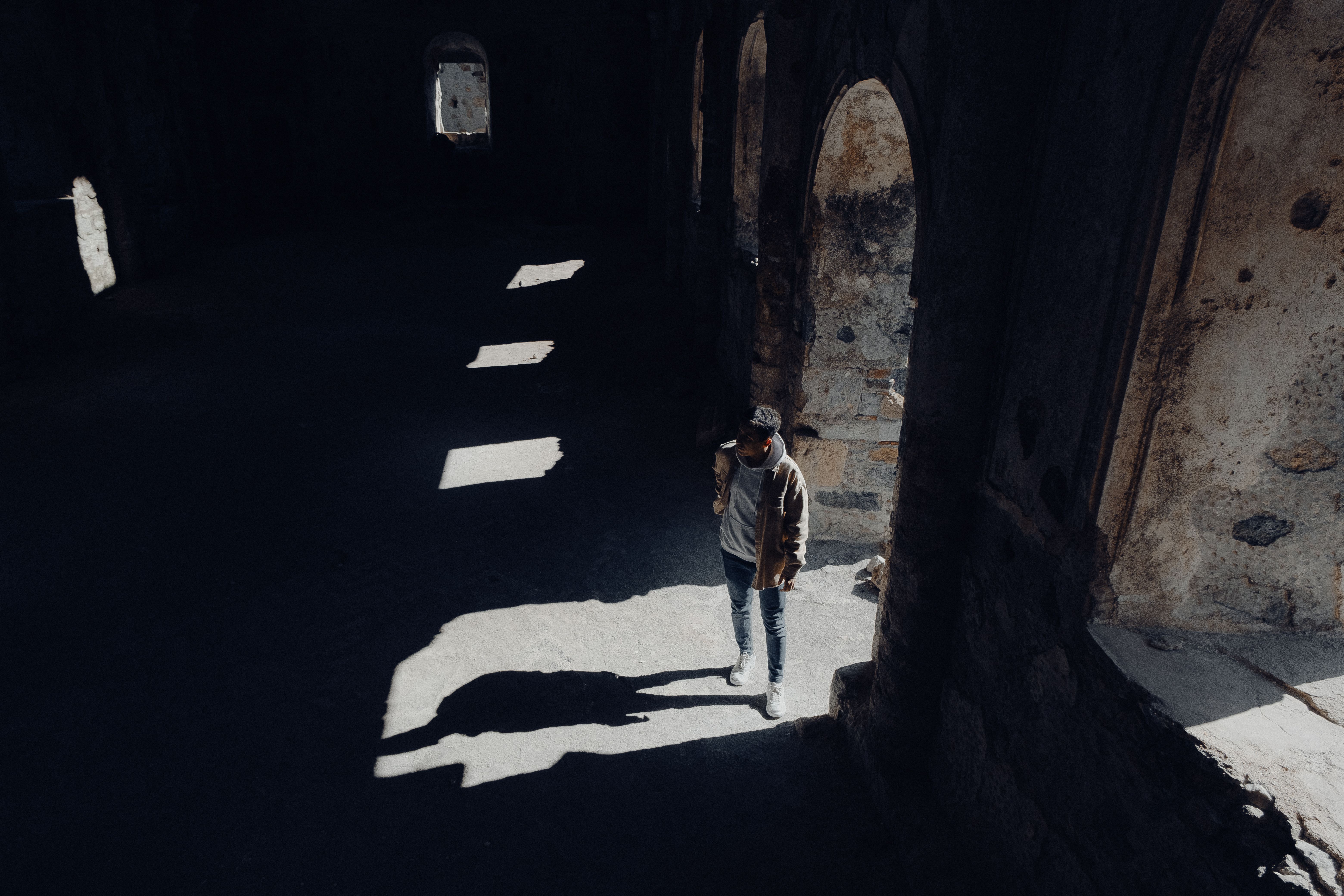 Man in Jacket Exploring Abandoned Place · Free Stock Photo