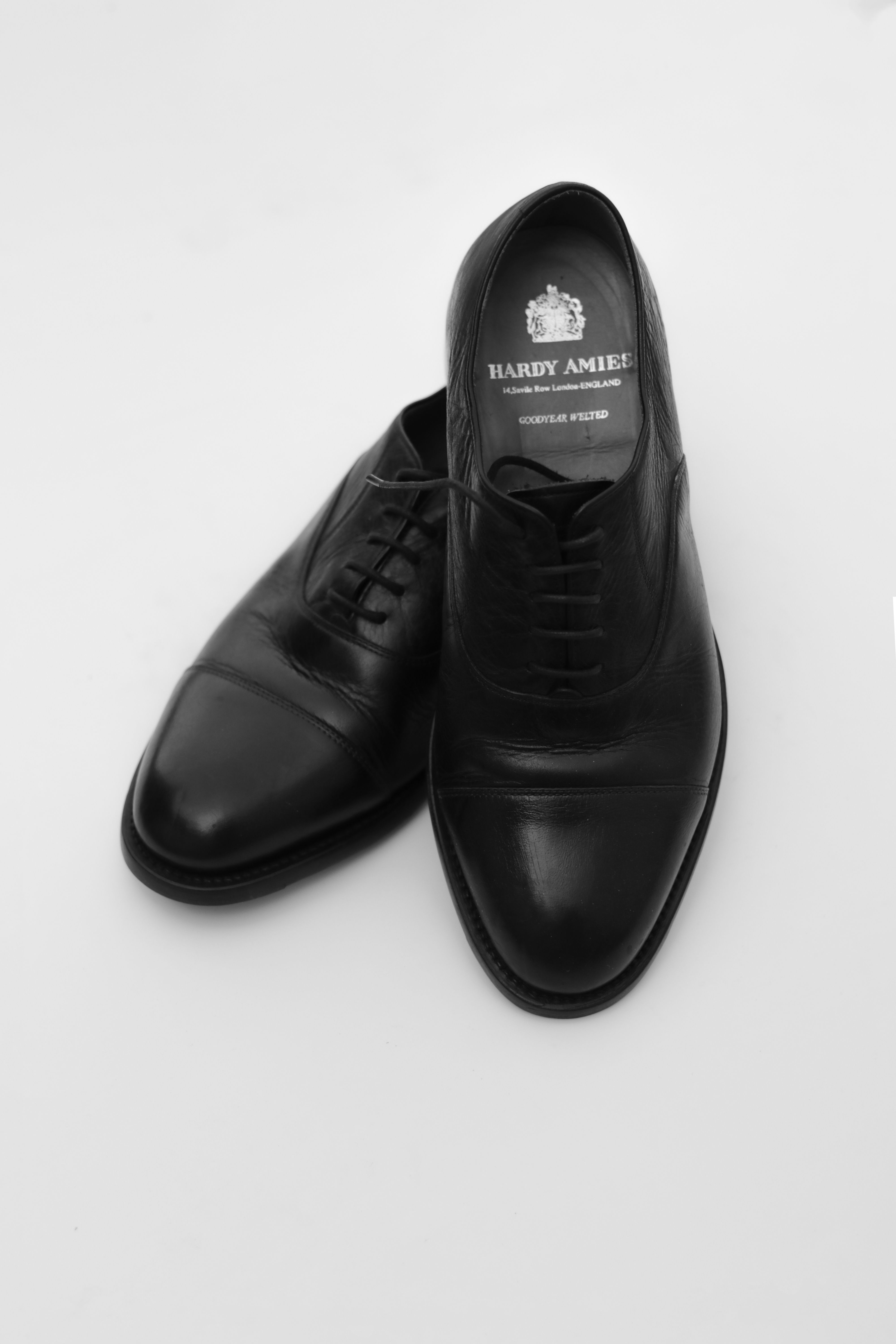 Pair of Elegant Black Shoes on White Surface · Free Stock Photo