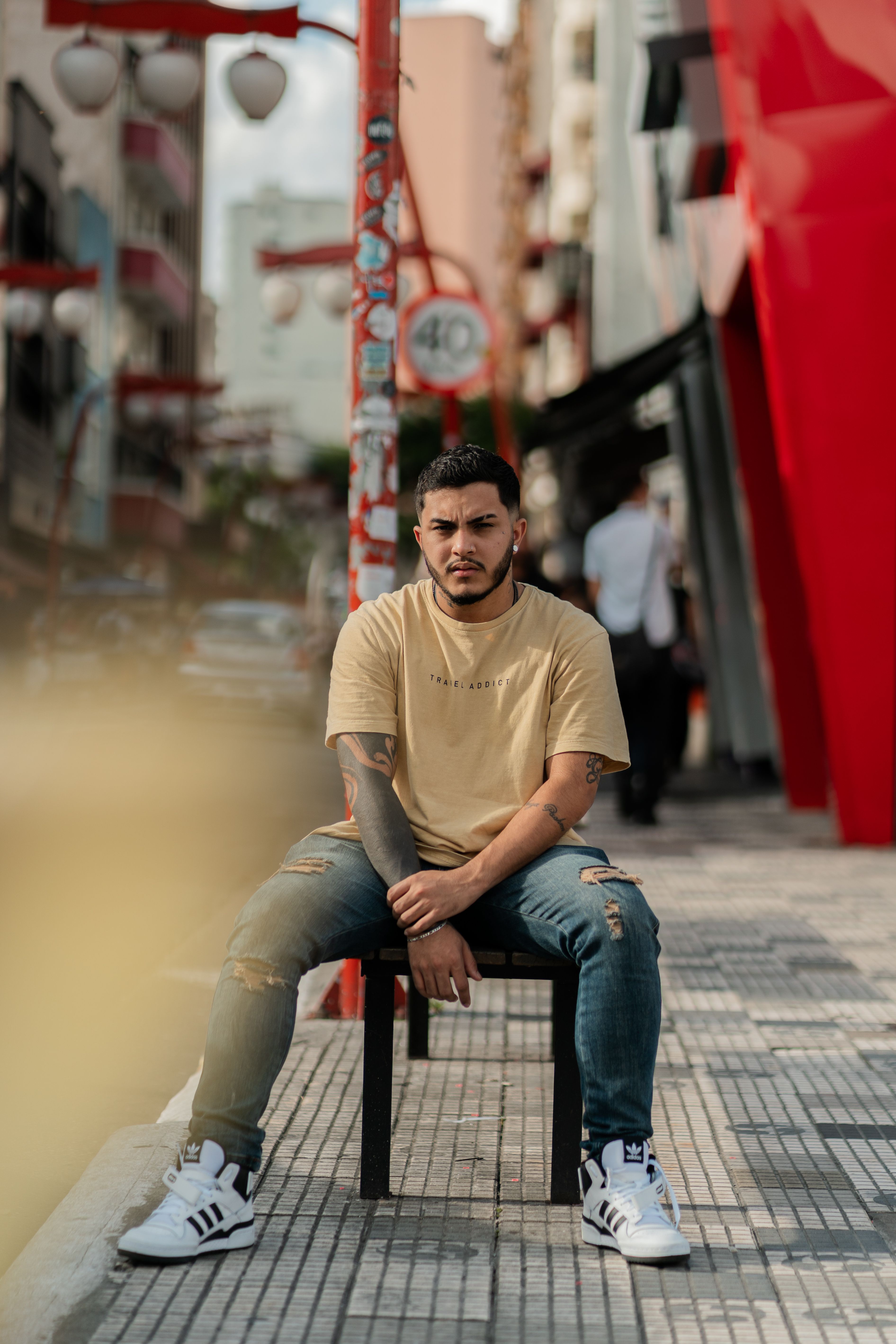 Man Sitting on the Chair in the Middle of Pedestrian Street · Free ...