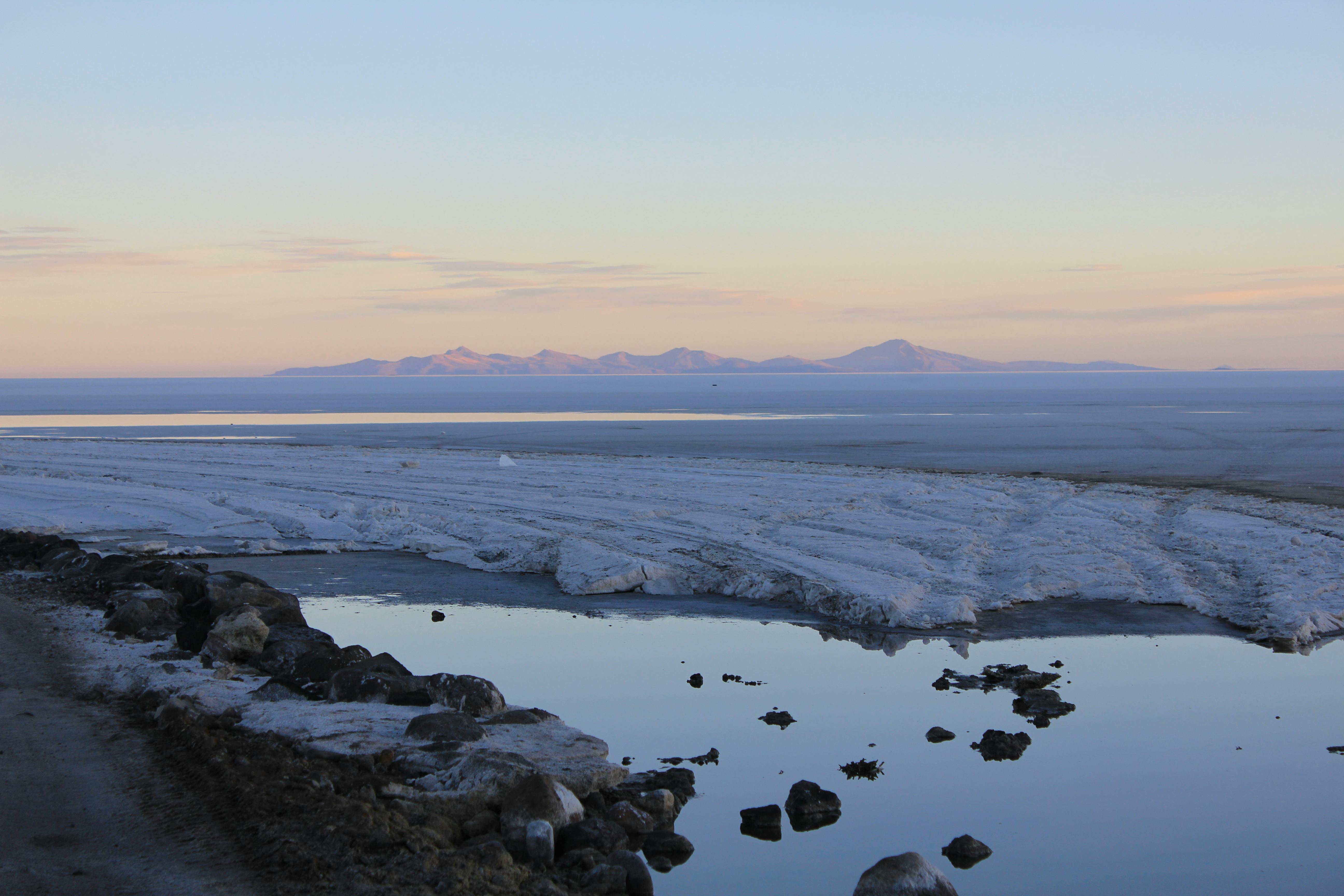 View of a an Icy Flatland and Mountains in Distance at Sunset · Free ...