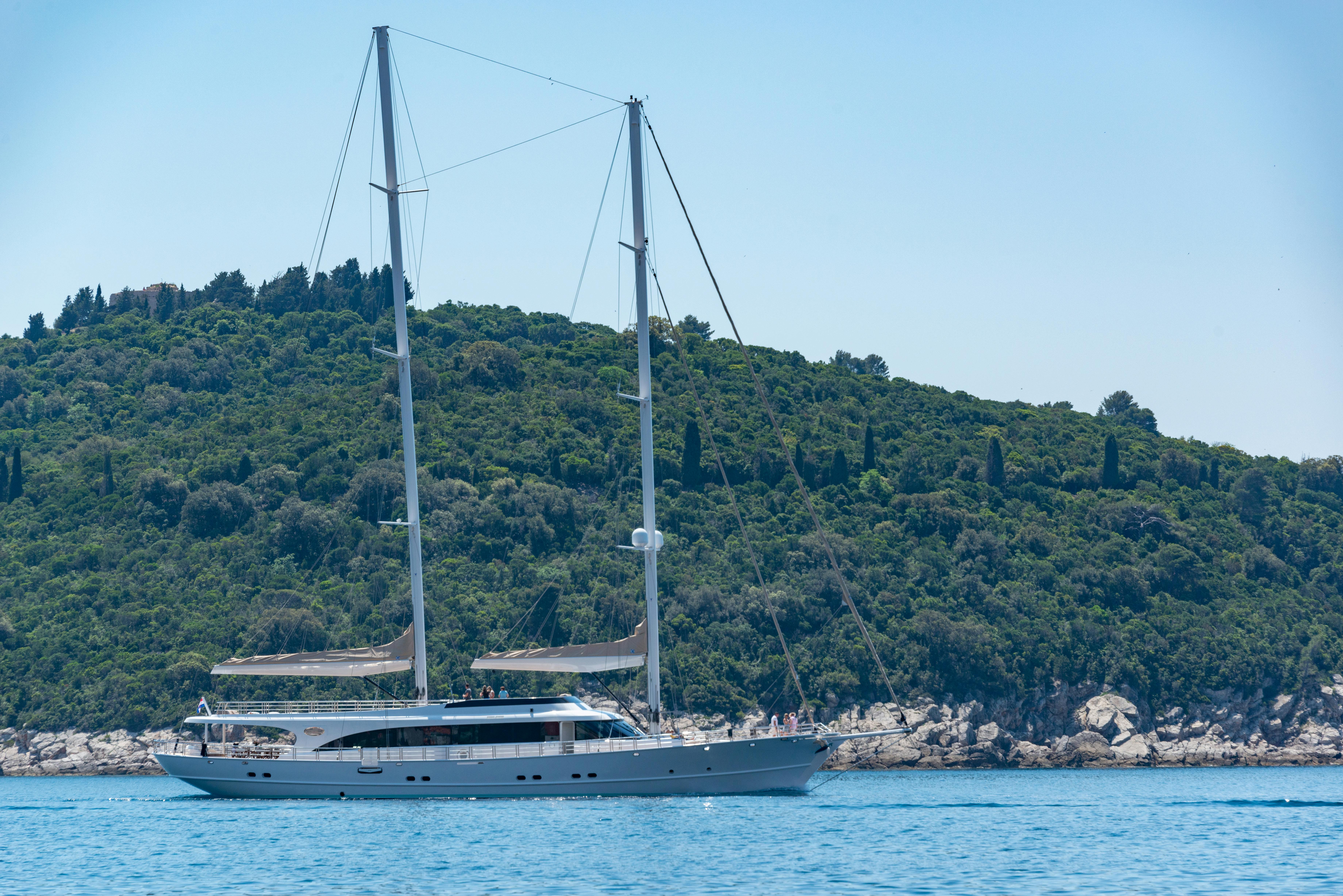 Motor Yacht Sailing near Sea Coast · Free Stock Photo
