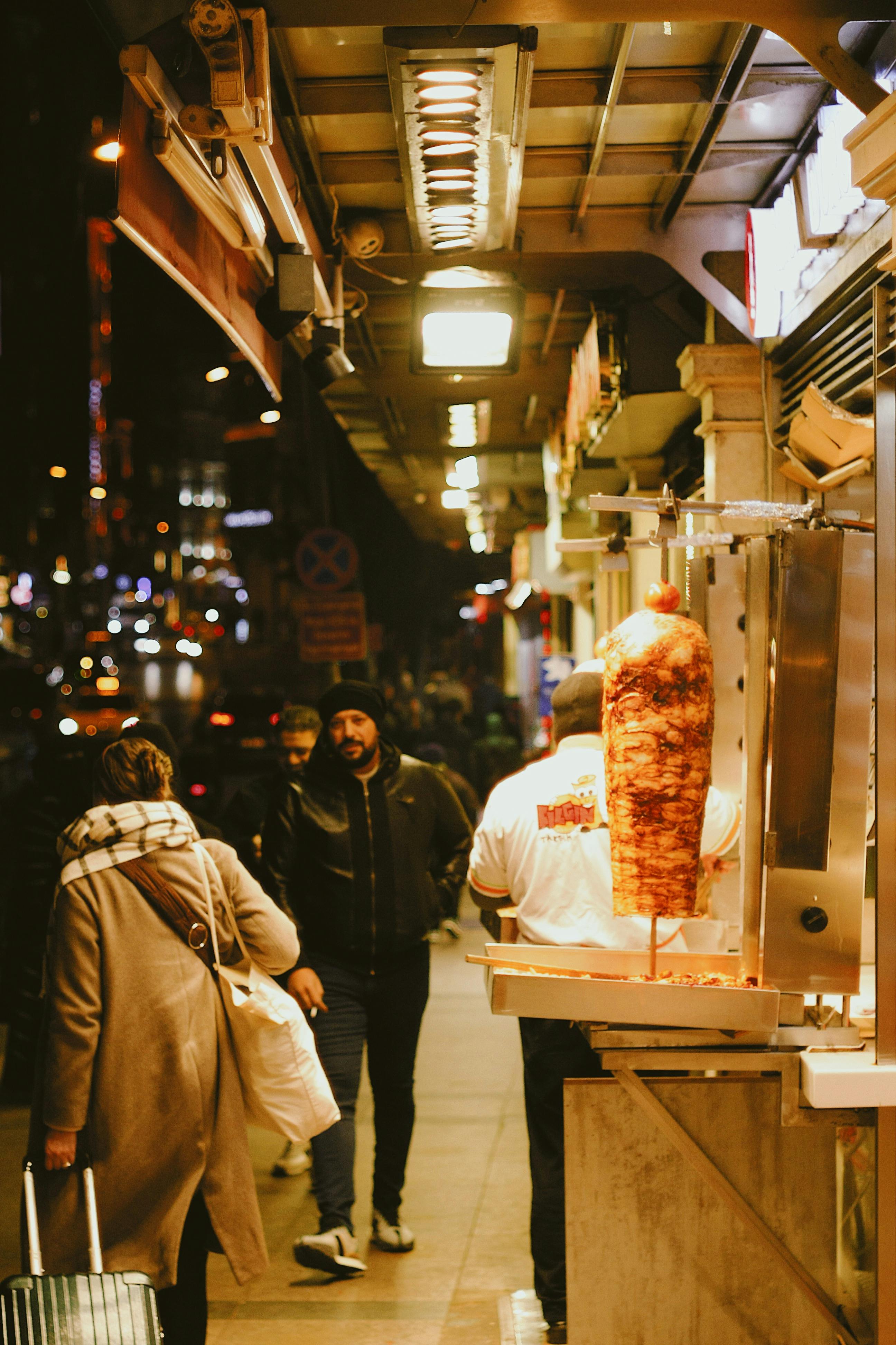People Walking past Kebab Restaurant at Night · Free Stock Photo
