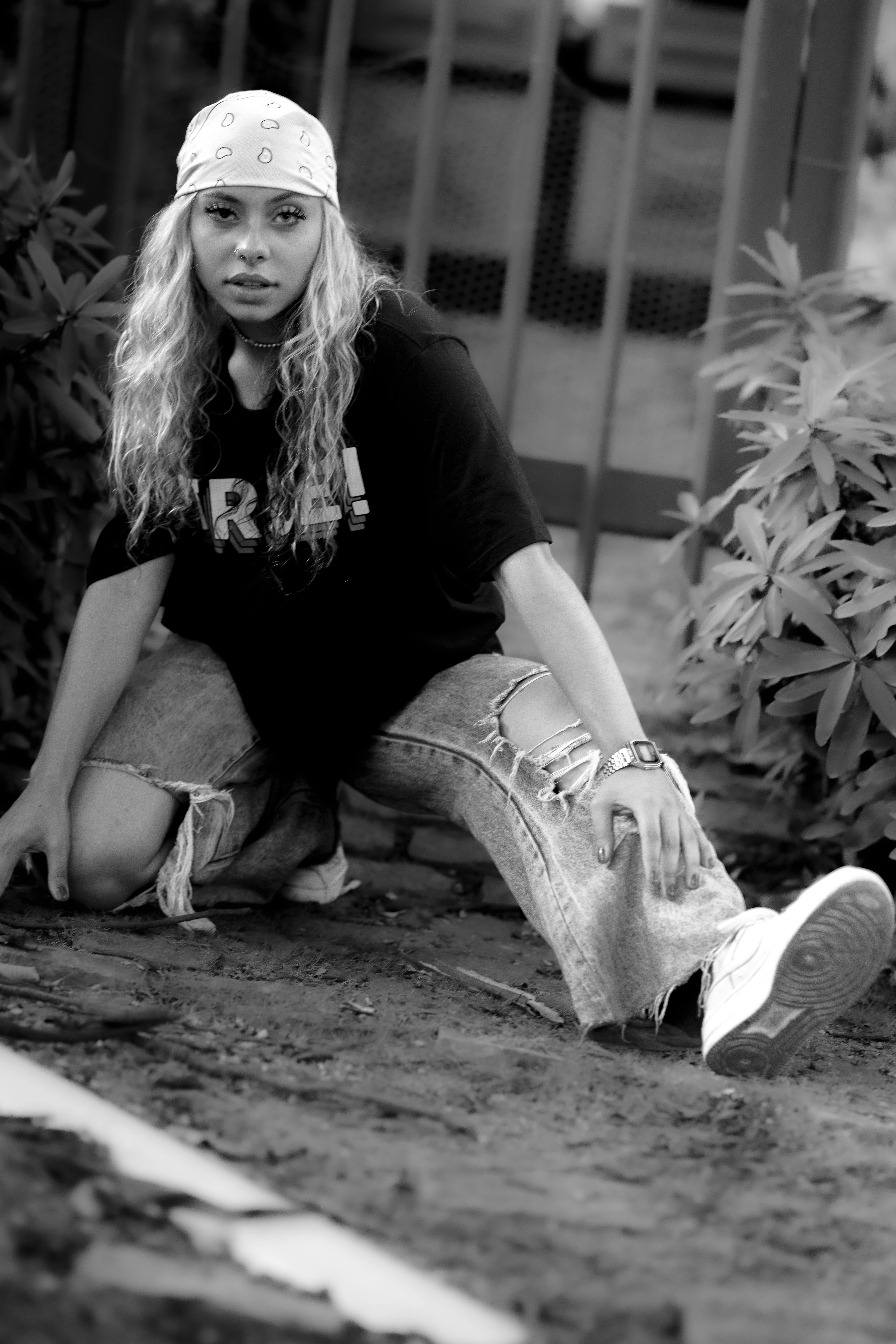 Woman Crouching on City Street · Free Stock Photo