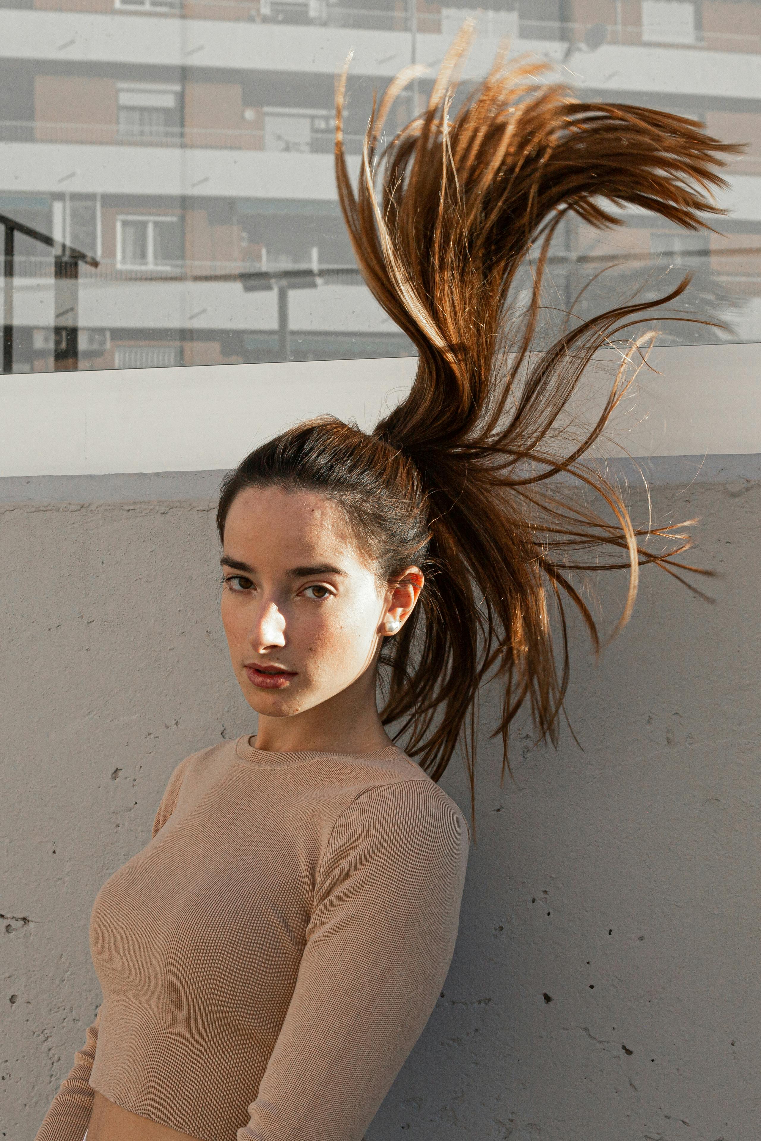 Woman Posing with Hair Raised Up · Free Stock Photo