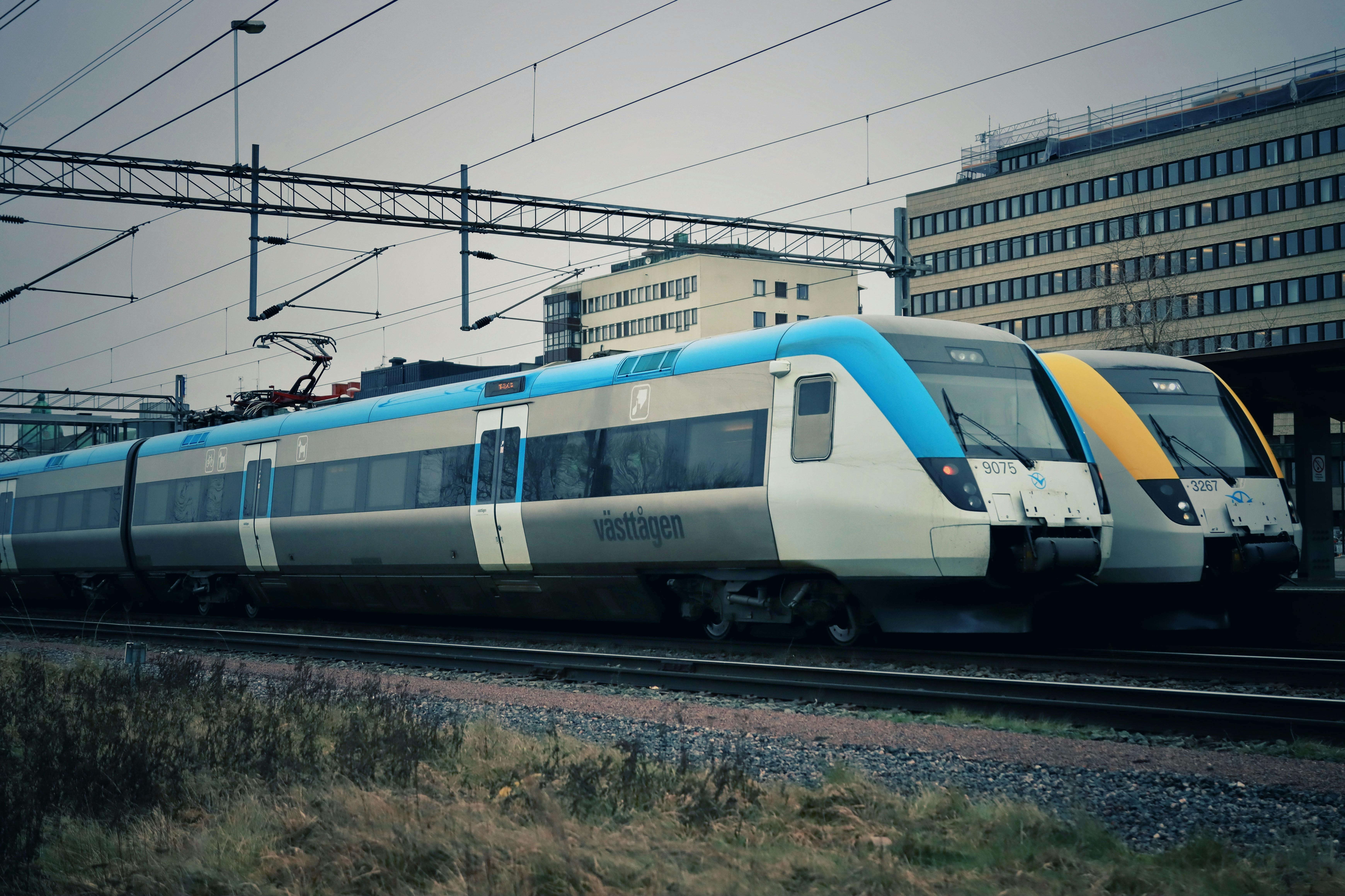 Modern Passenger Trains on the Railway Tracks · Free Stock Photo