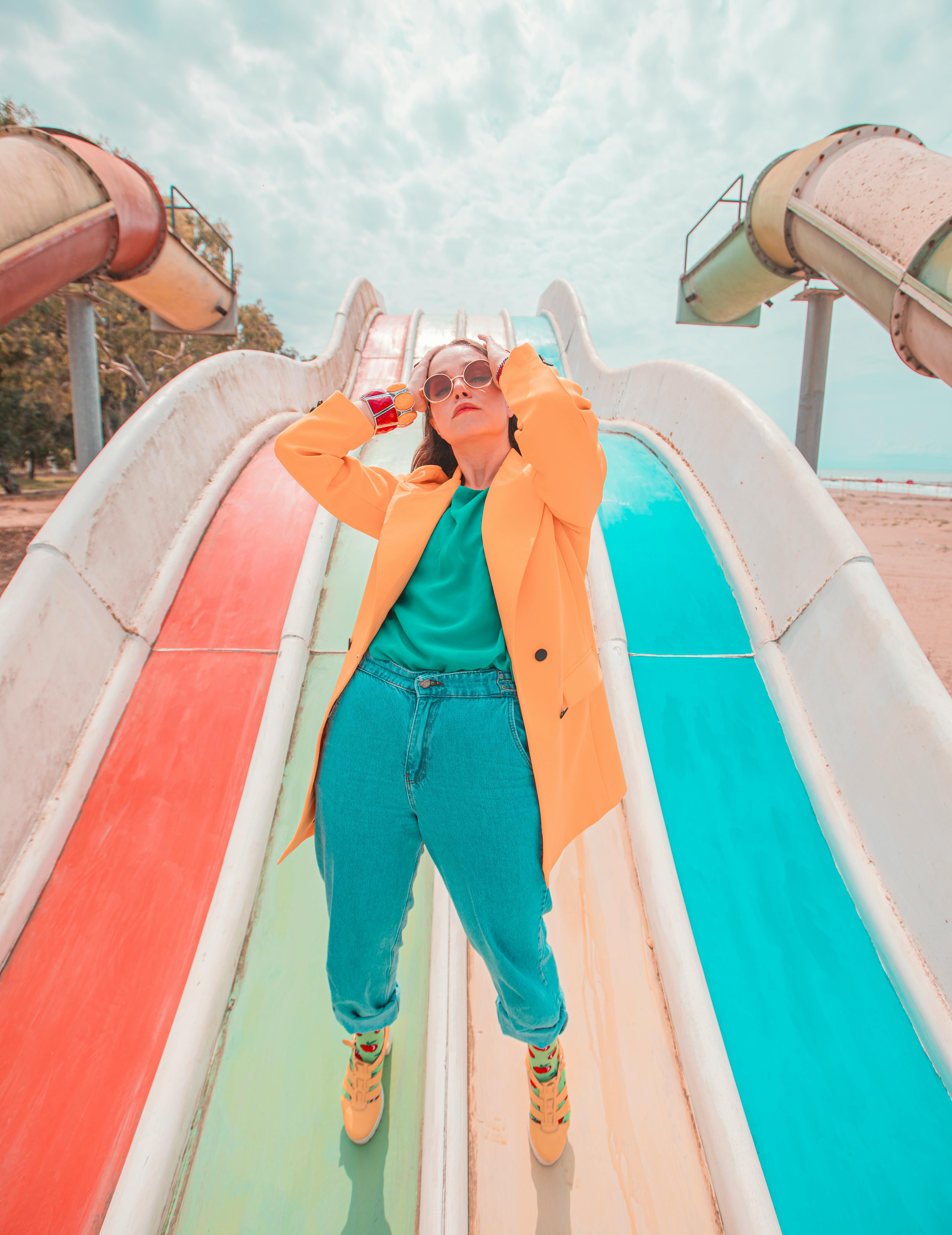 Woman Posing on Colorful Slides in Water Park · Free Stock Photo
