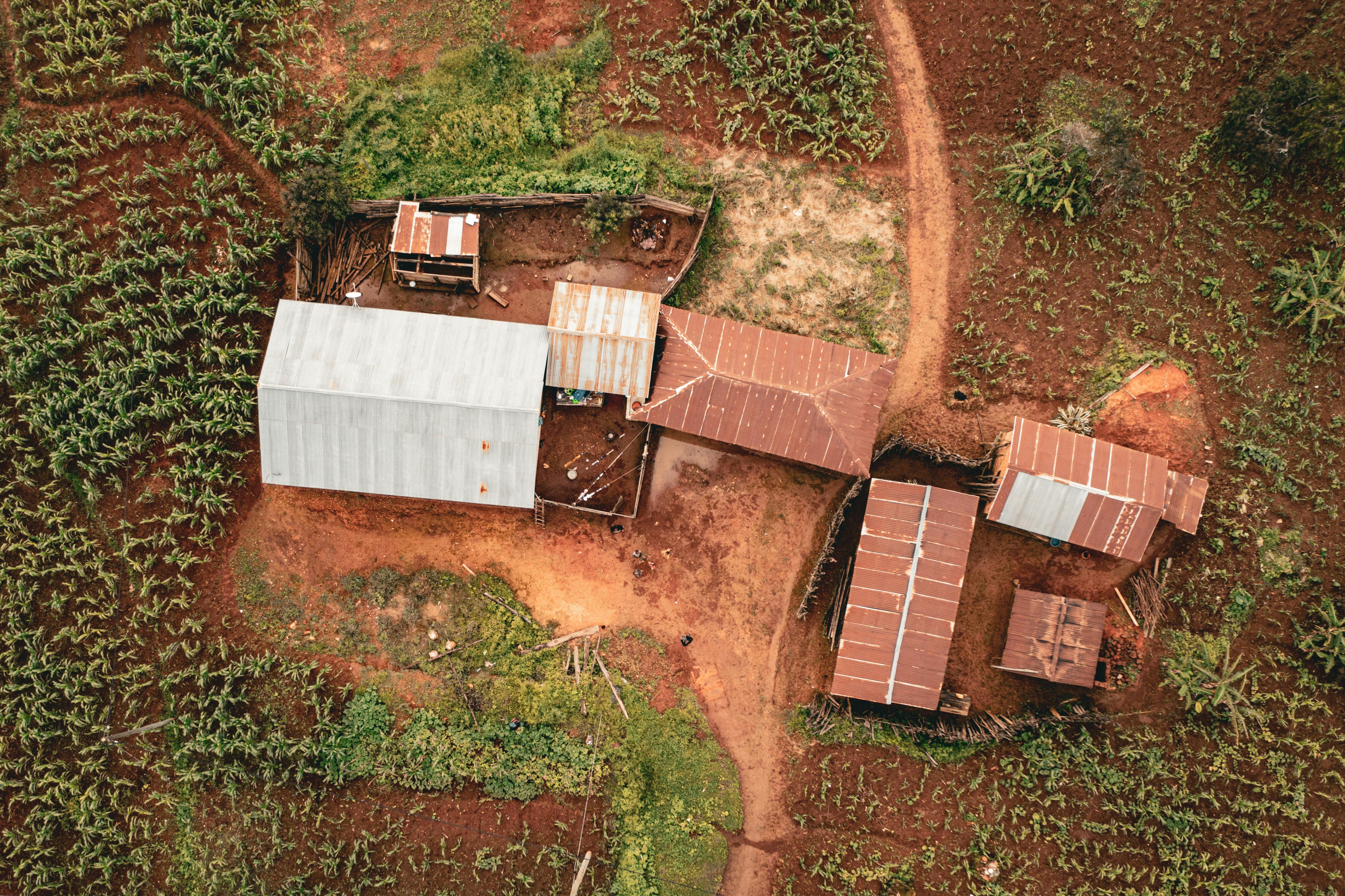 Aerial View of Red and White Painted Barn Near Green Grass Yard · Free ...