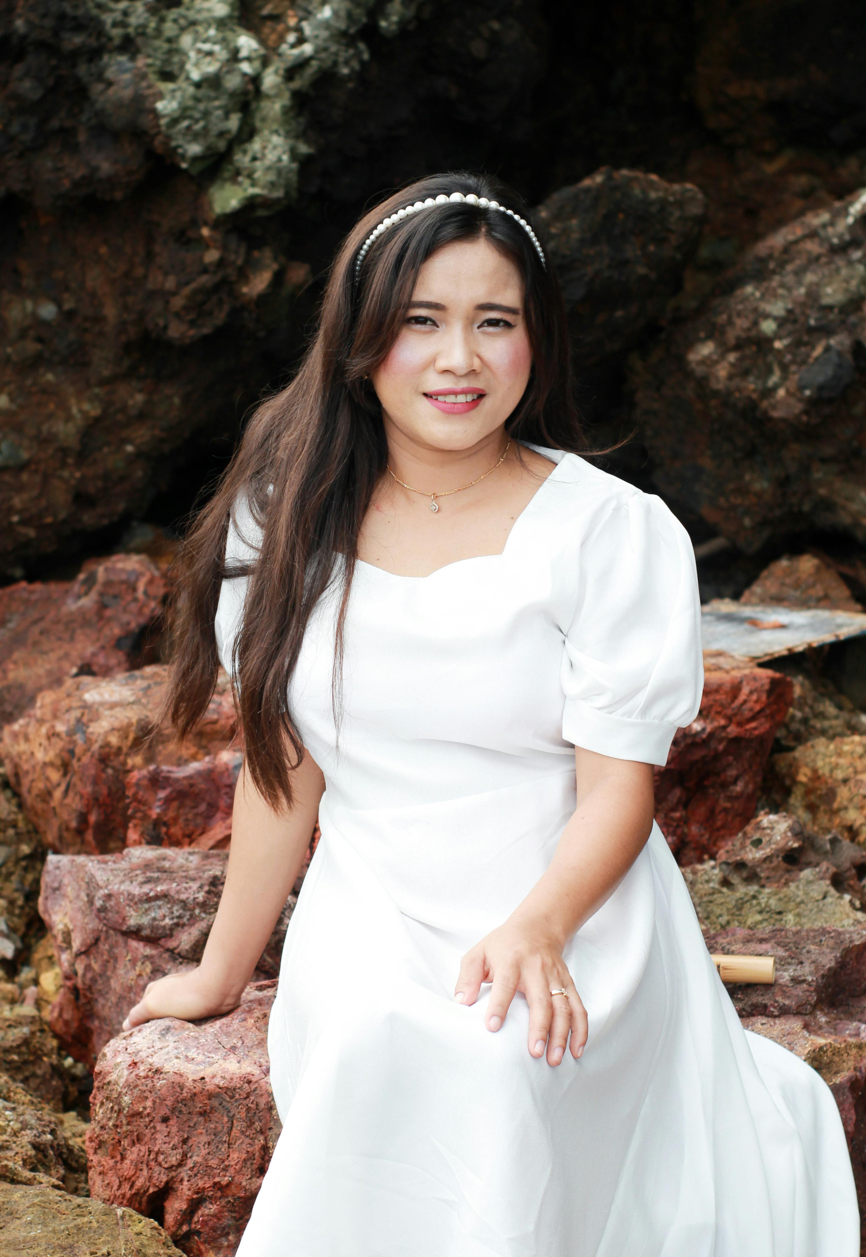 Woman in a White Dress Sitting on a Rock · Free Stock Photo