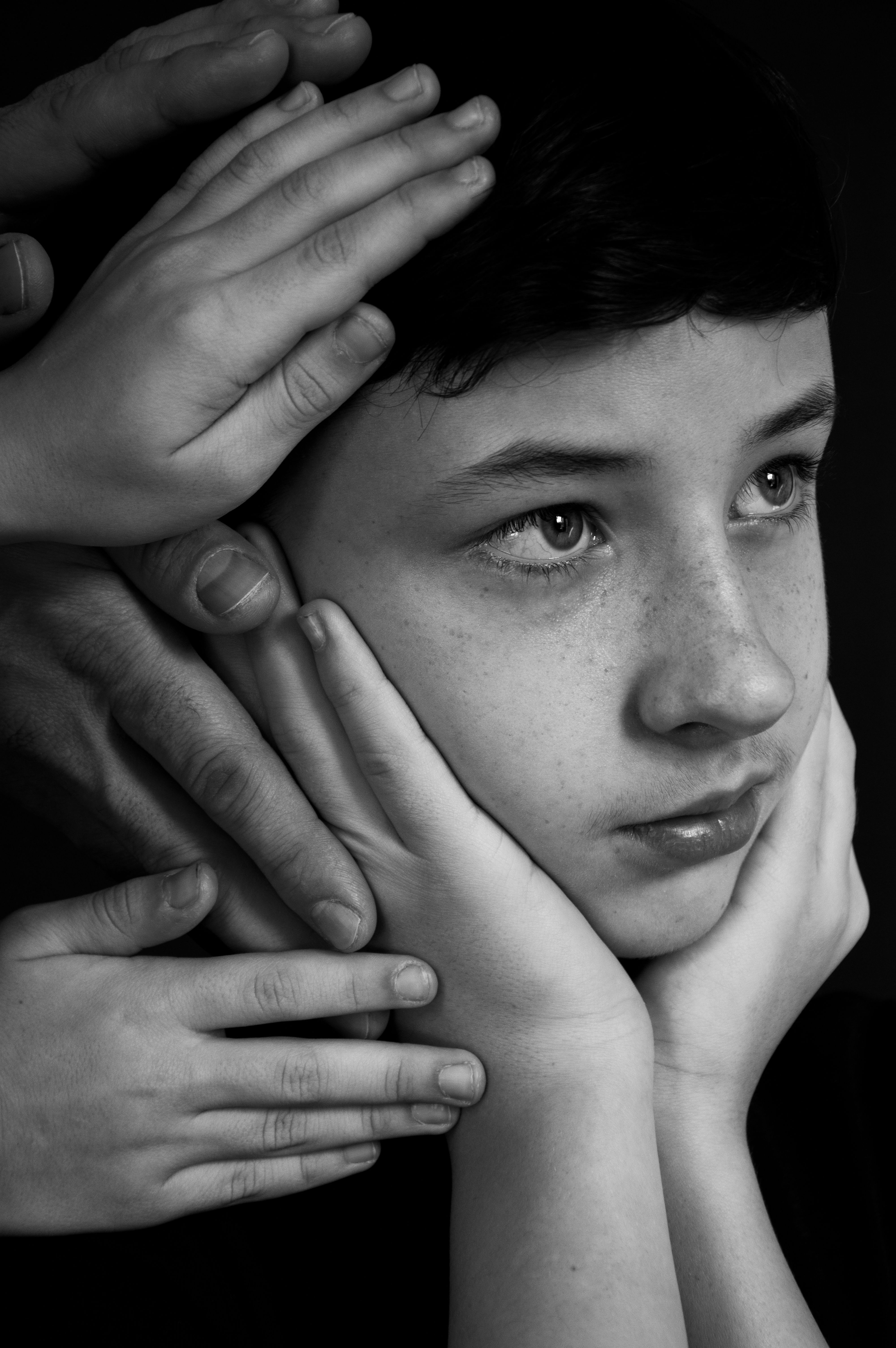 Hands around Boy Face · Free Stock Photo