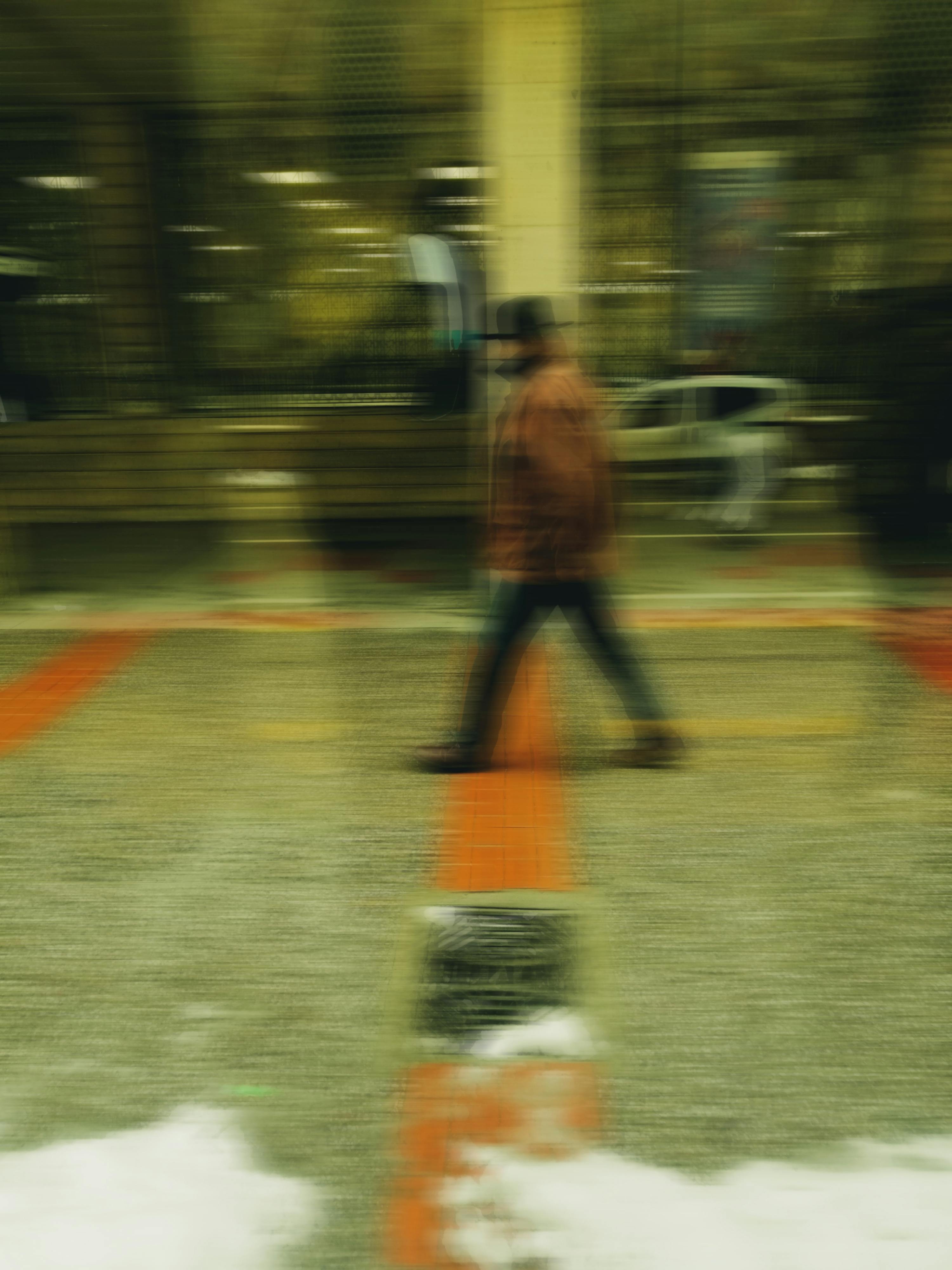 Blurred Man Walking on Pavement · Free Stock Photo