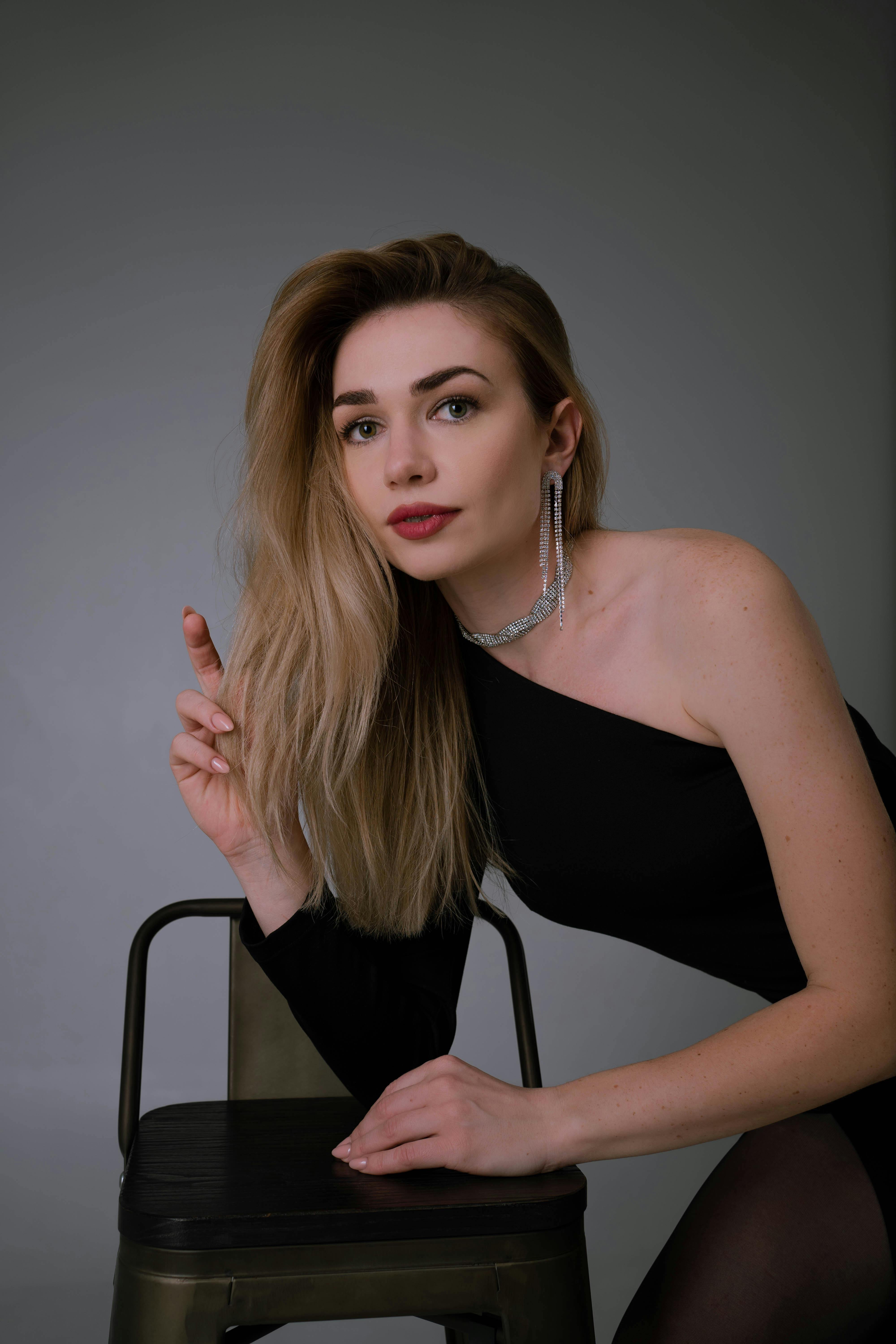 Woman Leaning on Stool · Free Stock Photo