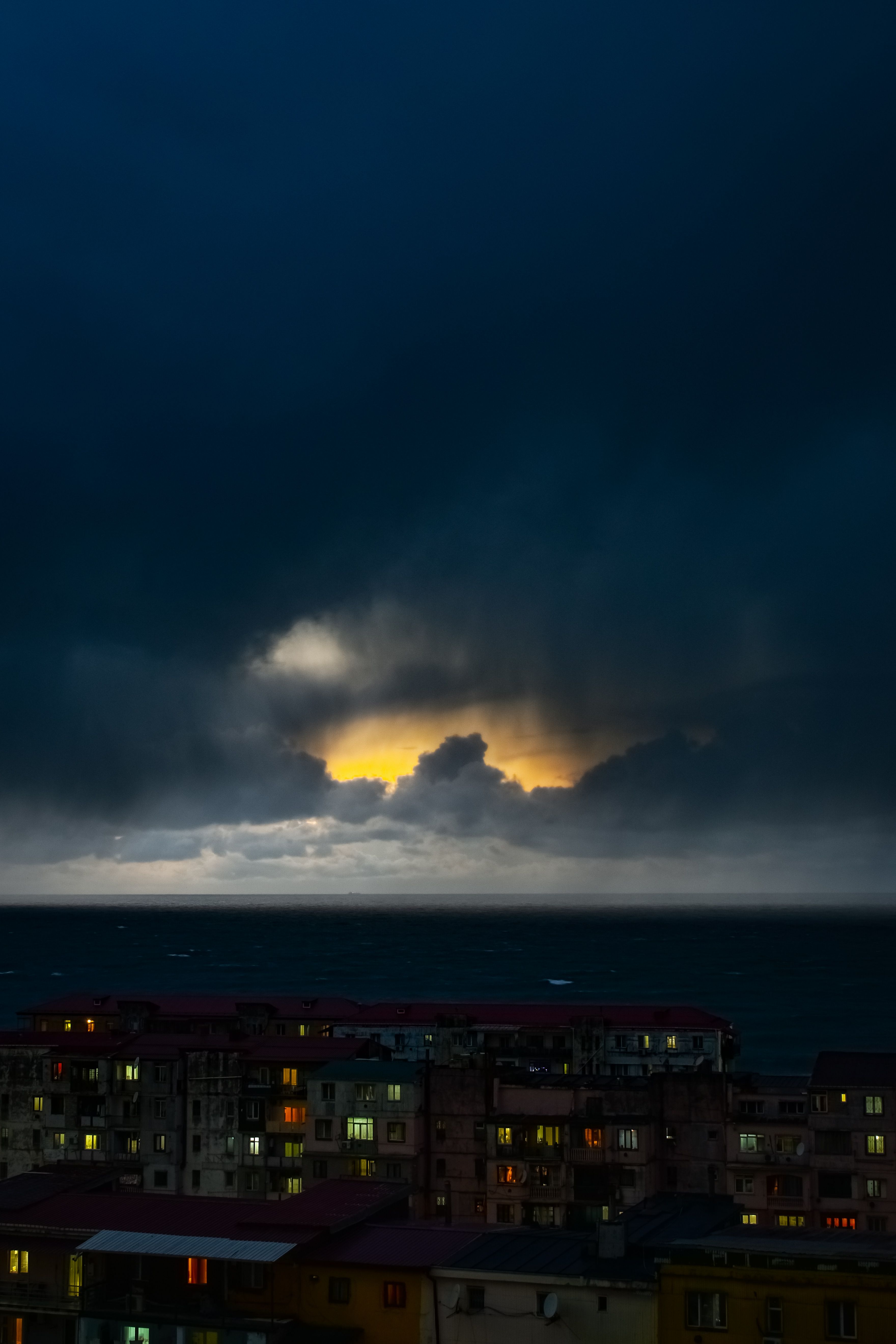 Dark Cityscape with Blocks of Flats and Dramatic Sky · Free Stock Photo