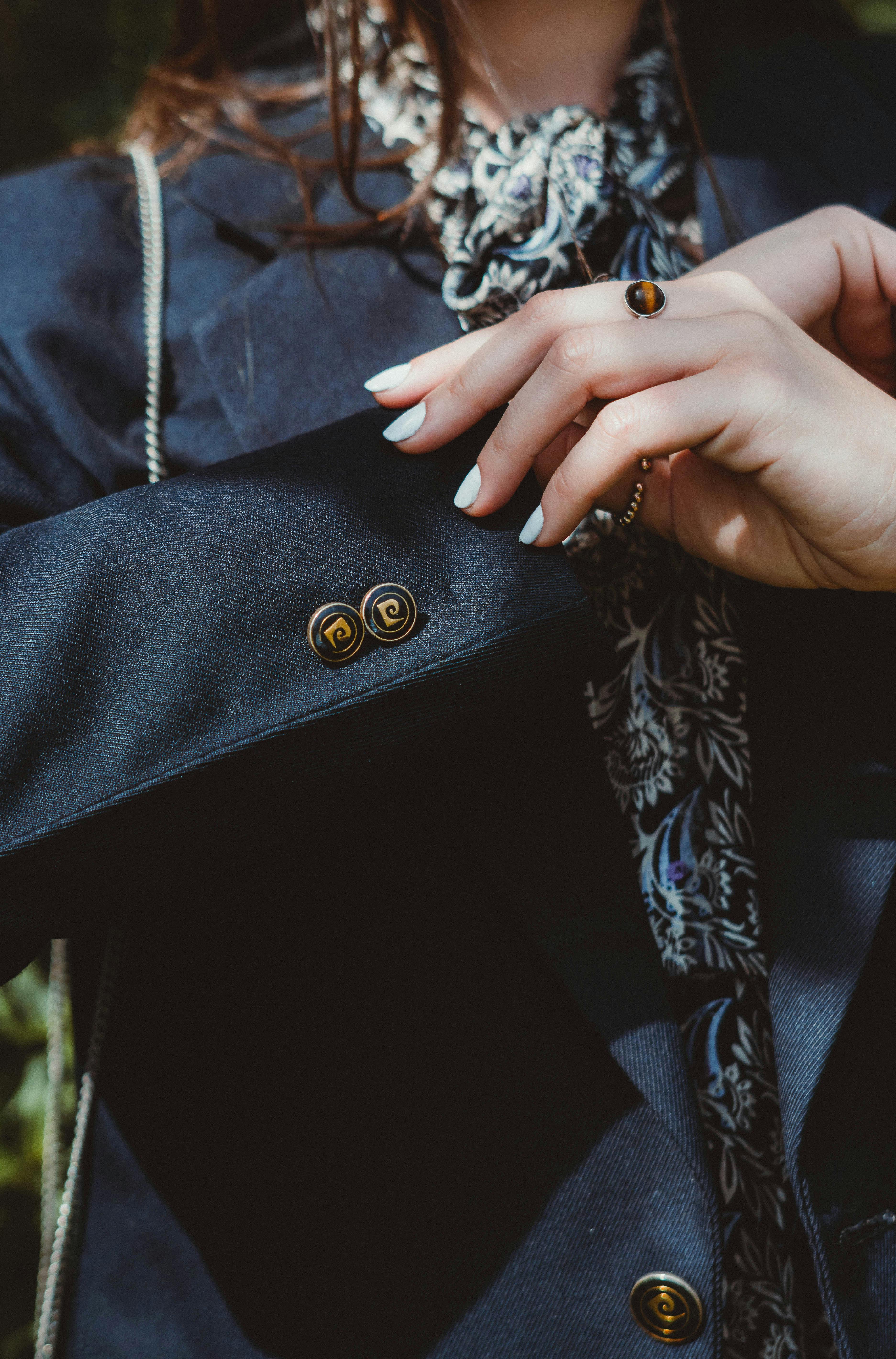 Model Adjusting the Cuff of Her Navy Blue Blazer · Free Stock Photo
