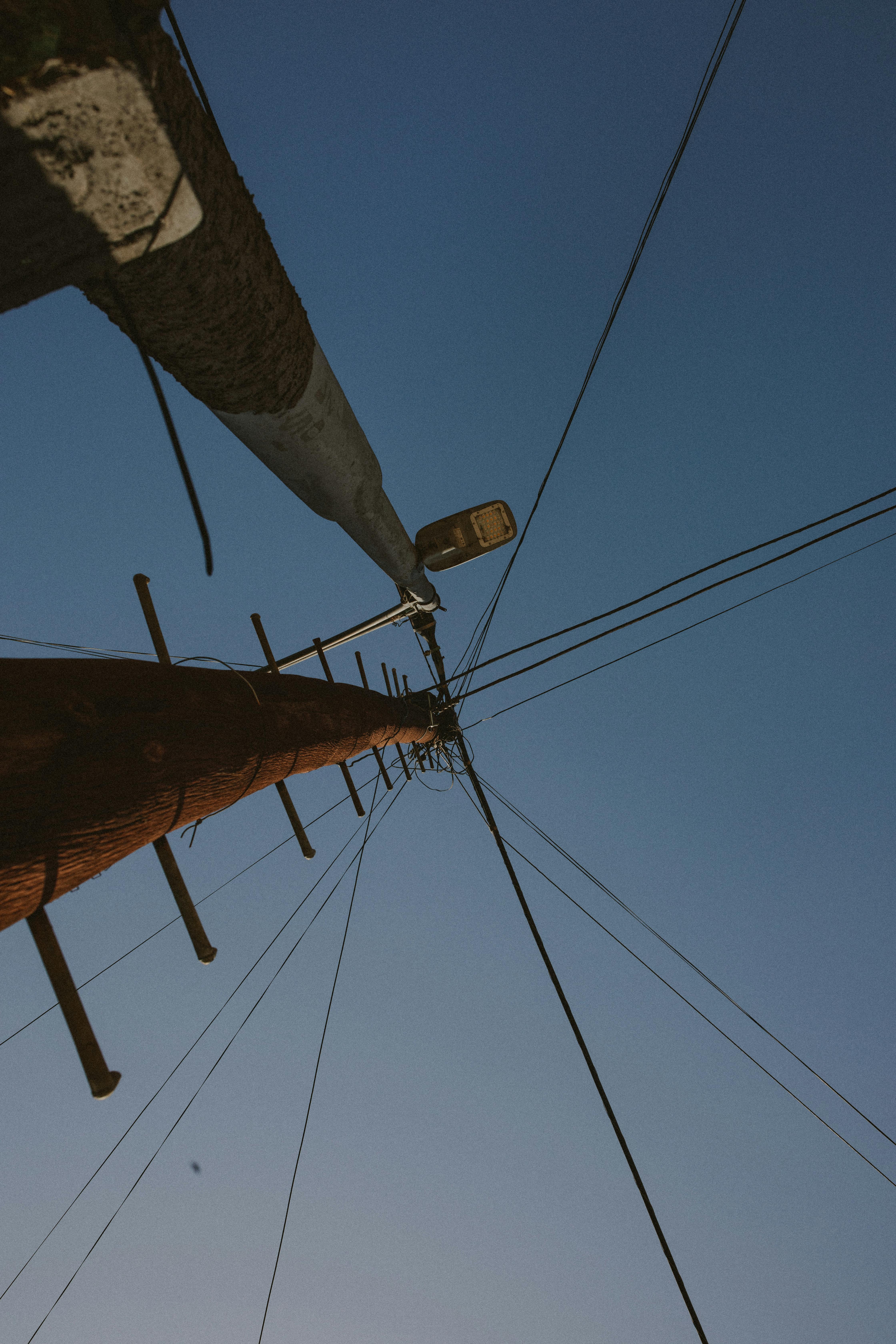 Wooden Utility Pole against Blue Sky · Free Stock Photo