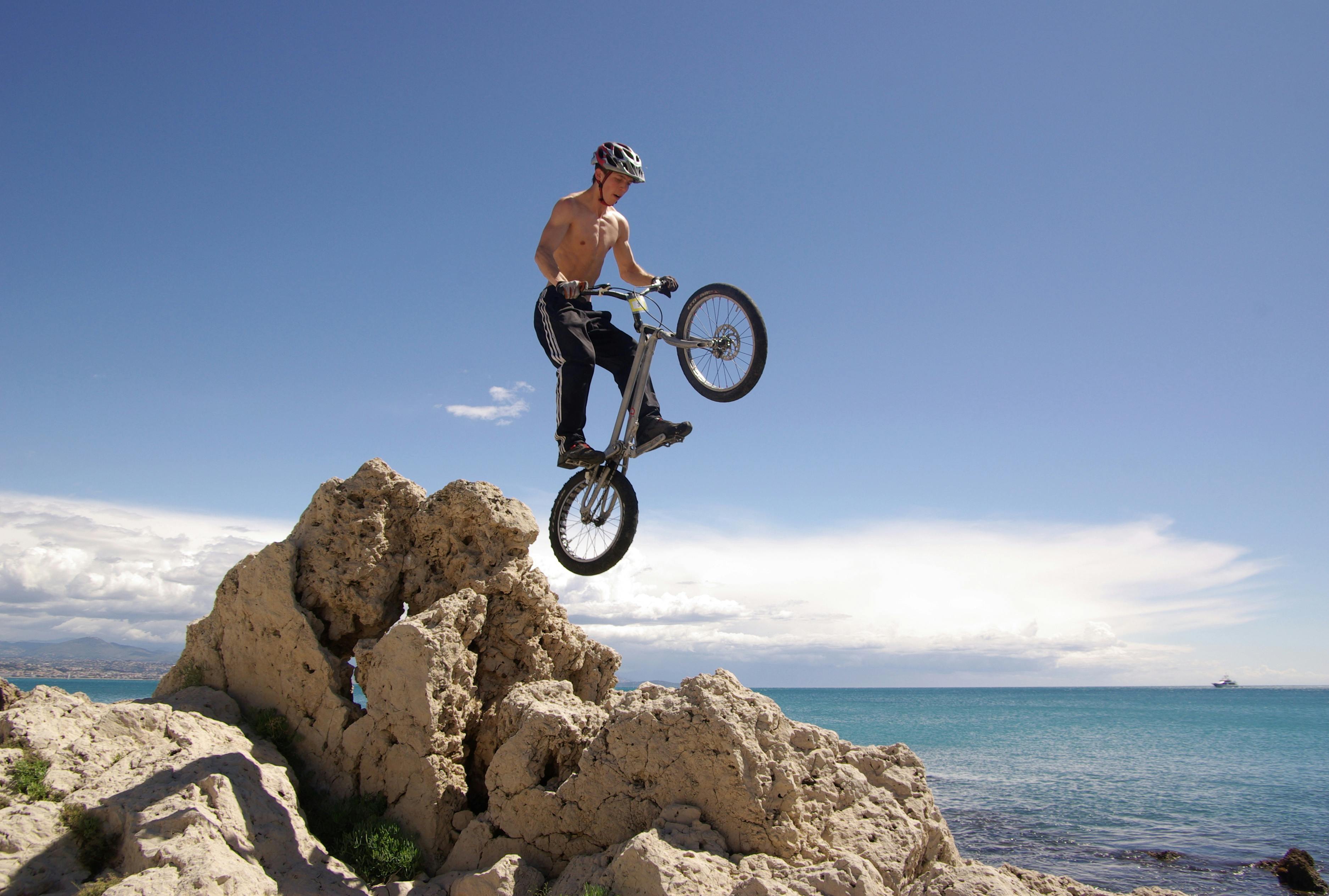 Cyclist Jumping on Rocks · Free Stock Photo