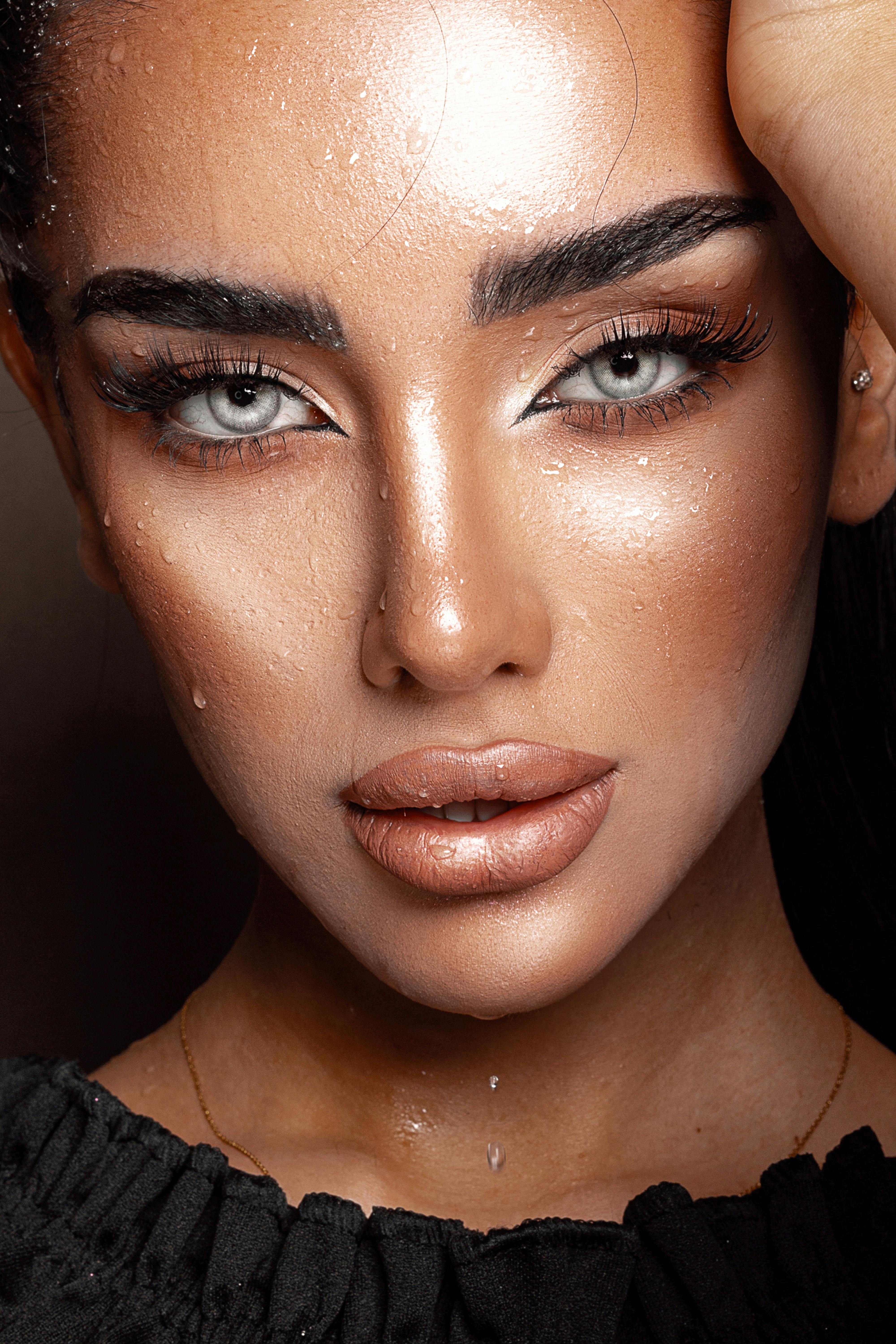 Model Posing in Glossy Makeup · Free Stock Photo