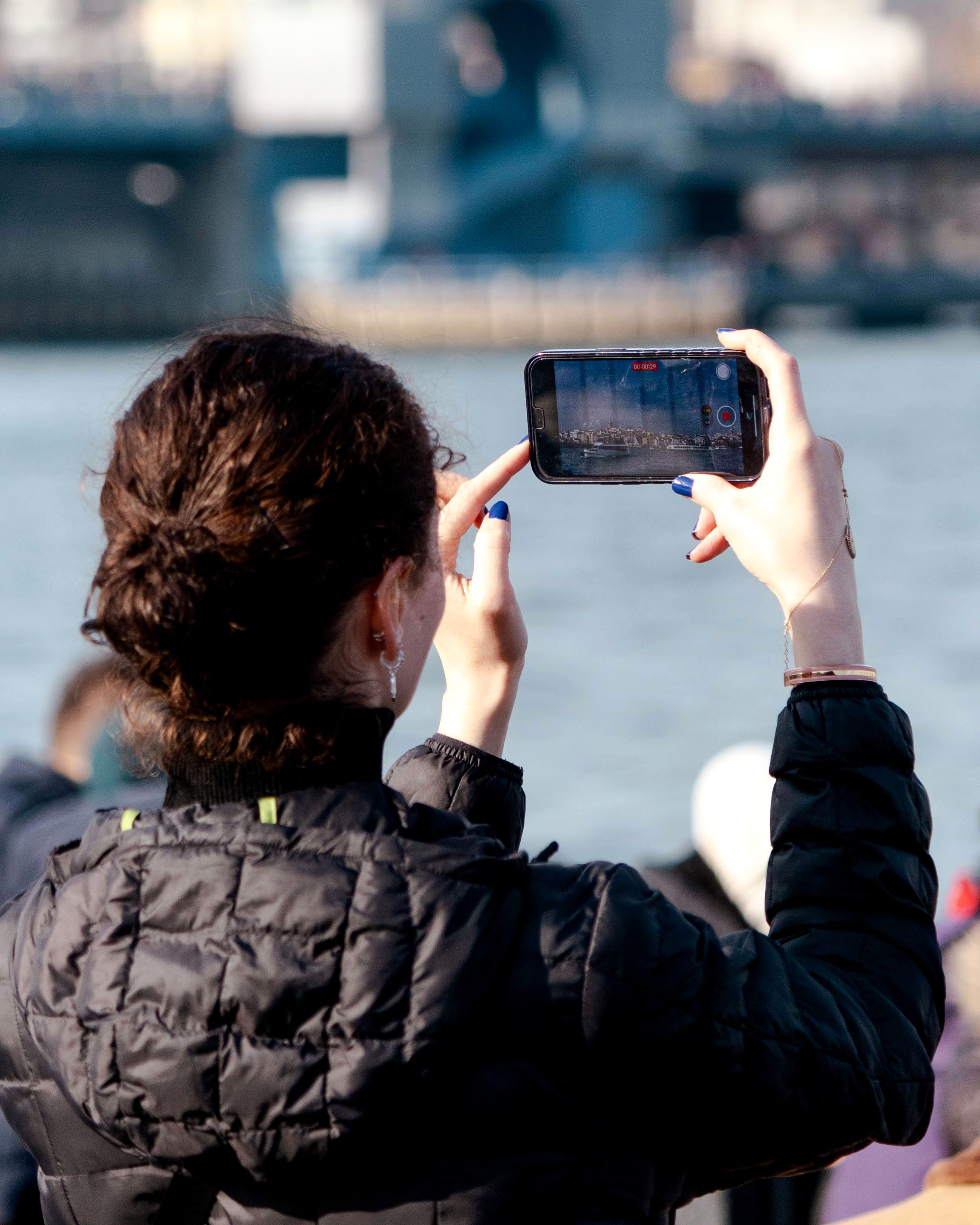 Woman Recording Performance on Phone · Free Stock Photo