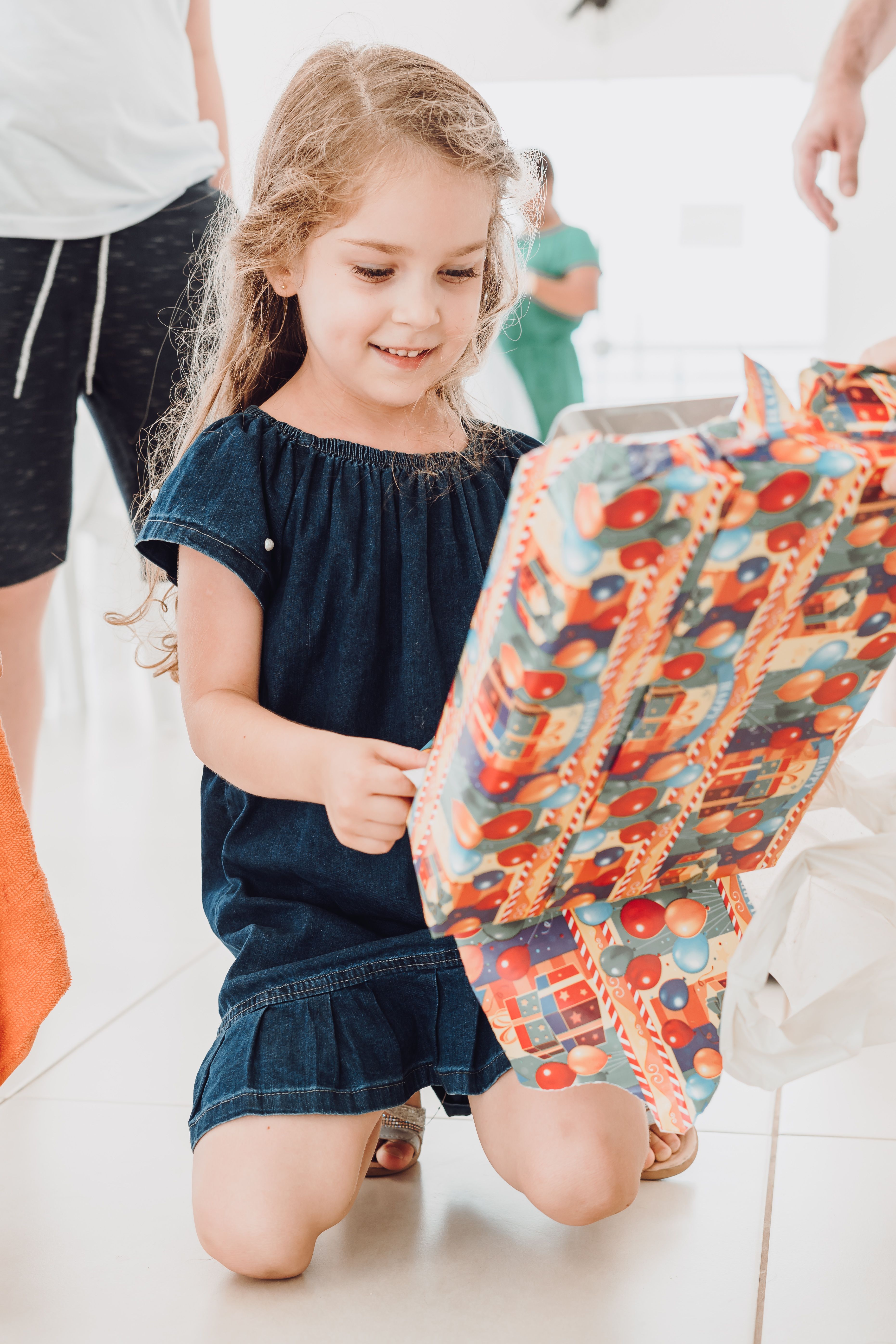 Girl Opening Present · Free Stock Photo