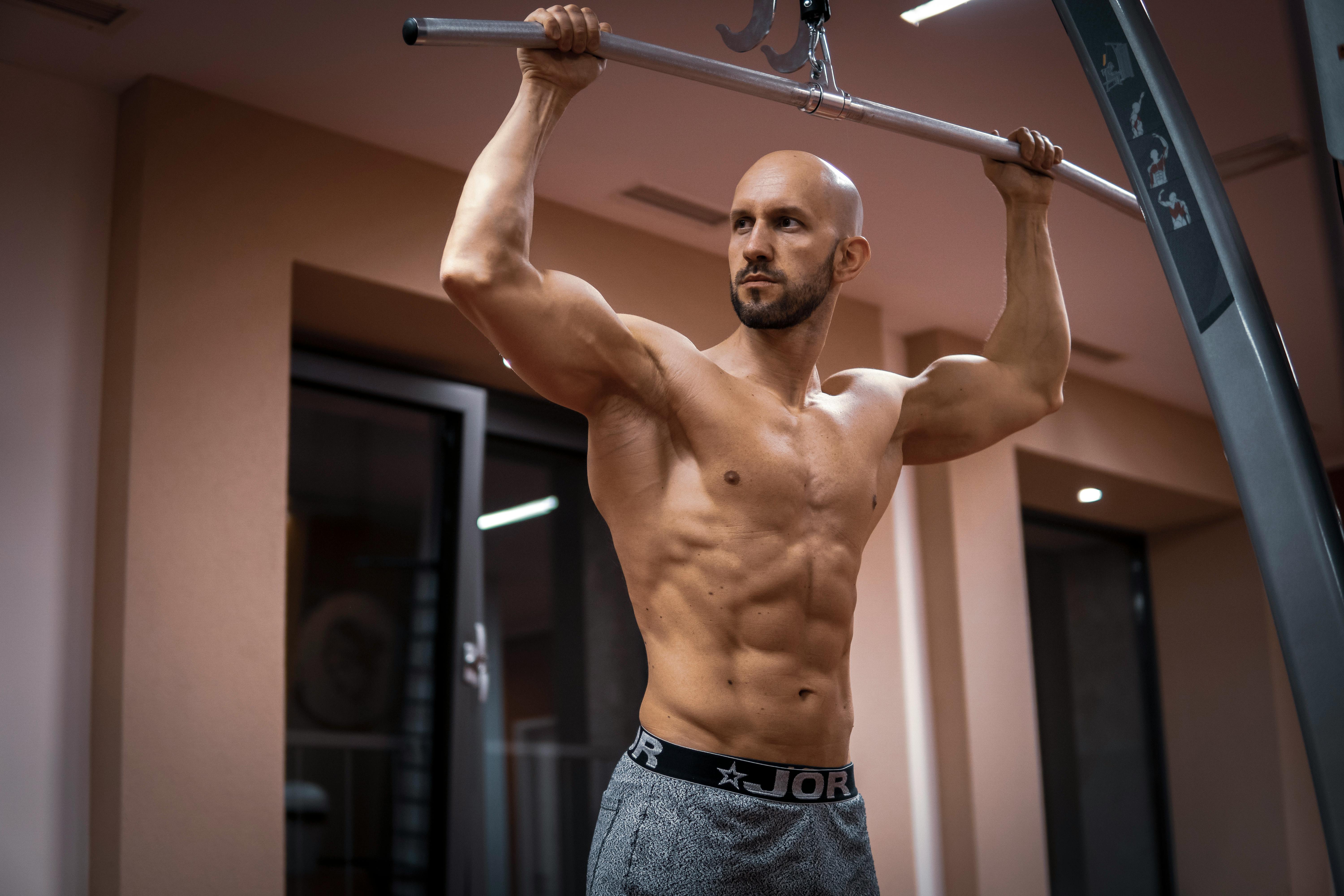Muscular Bald Man at Gym · Free Stock Photo