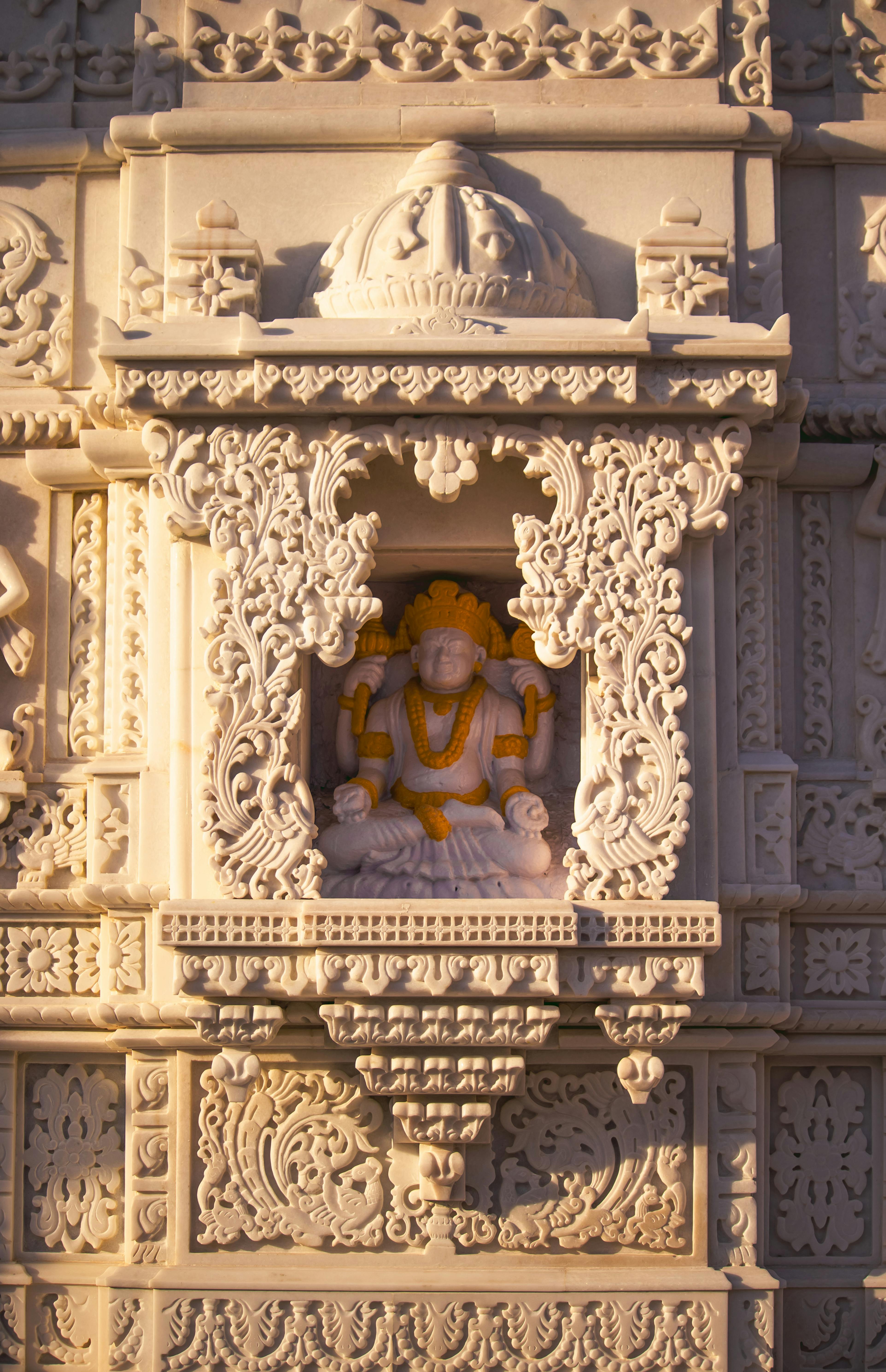 God Sculpture near Temple Wall · Free Stock Photo