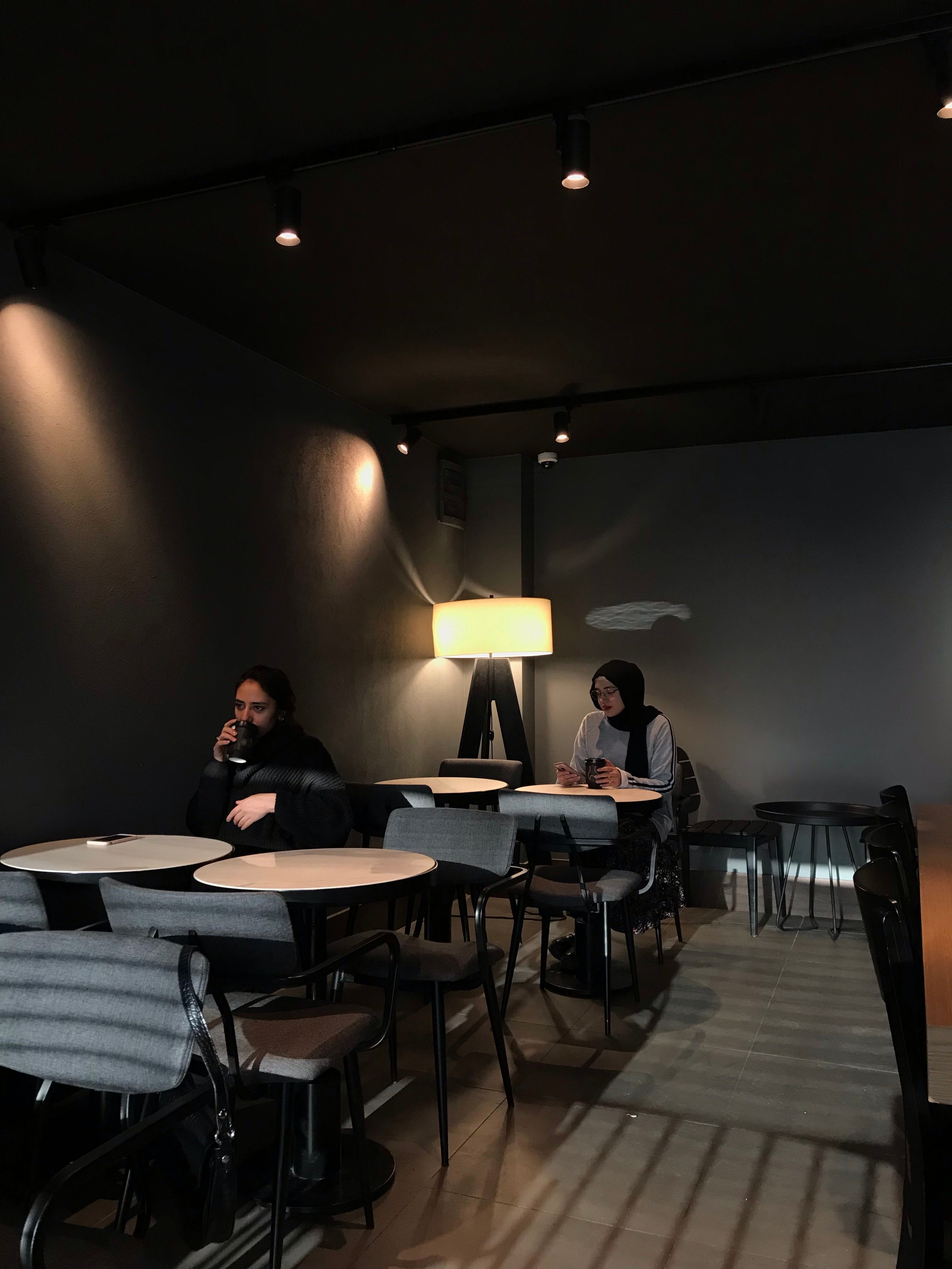 Woman Sitting at Cafe Table · Free Stock Photo