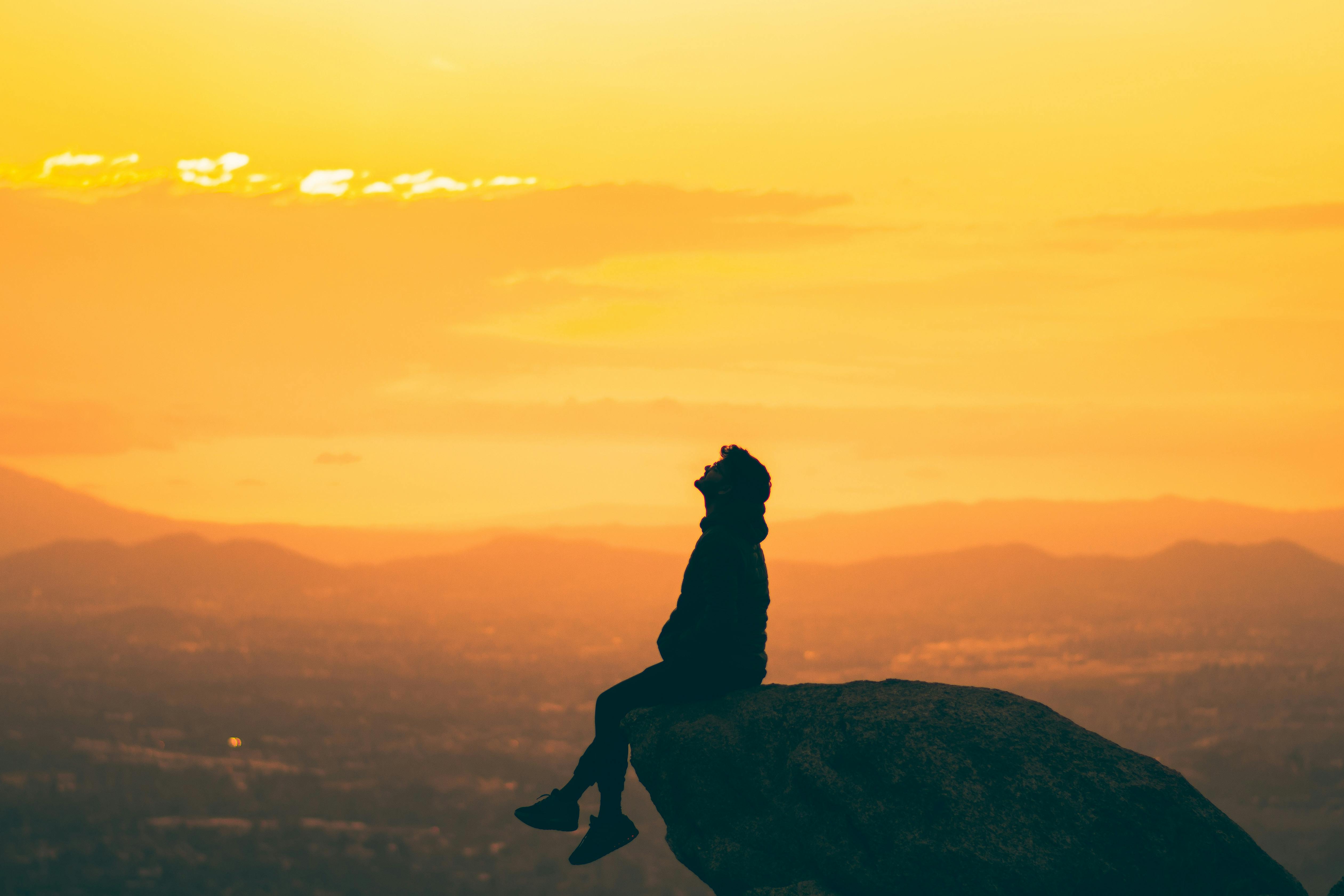 Silhouette of a Person Against Sunset Sky · Free Stock Photo
