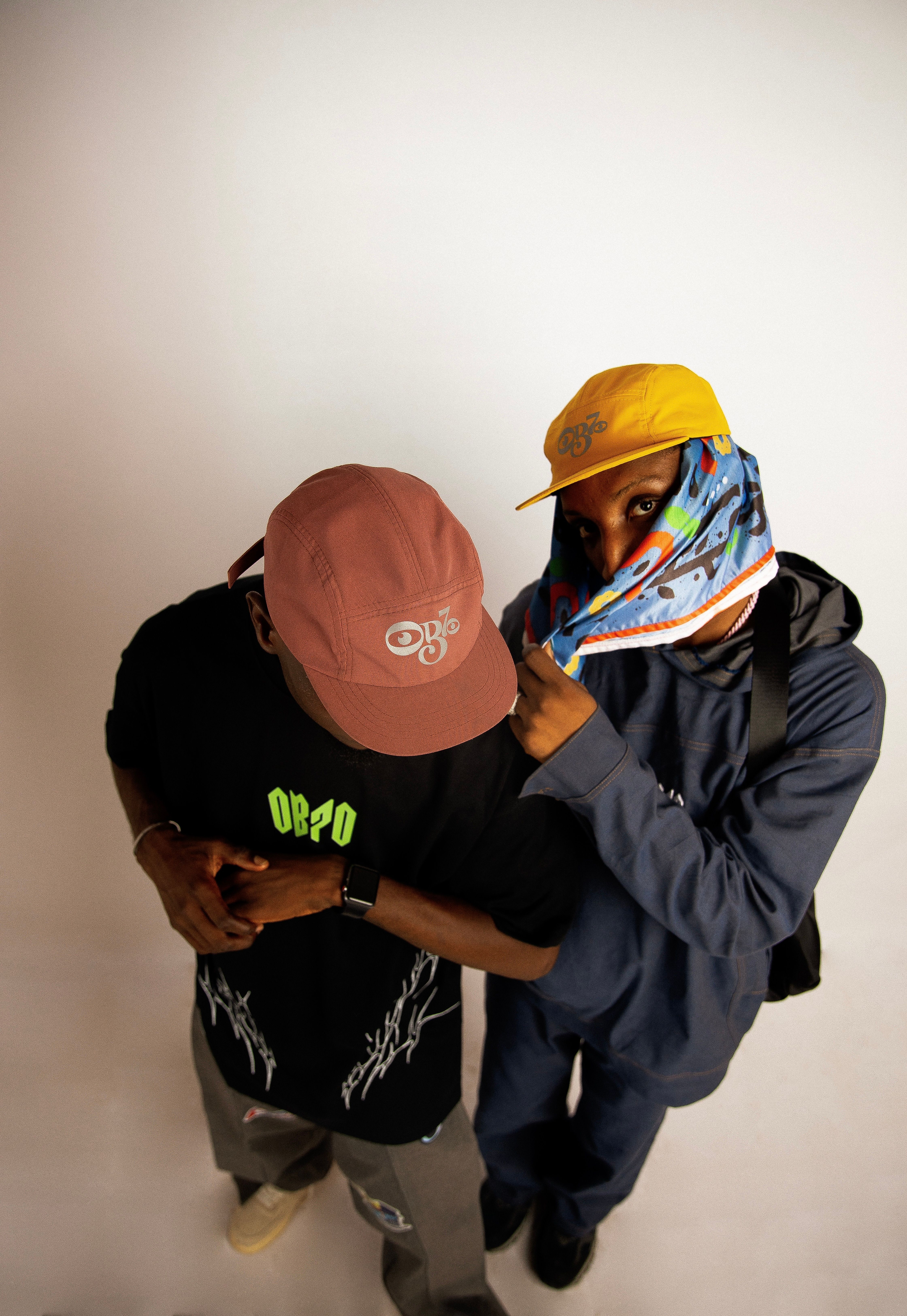 Man and Woman Posing in Caps · Free Stock Photo