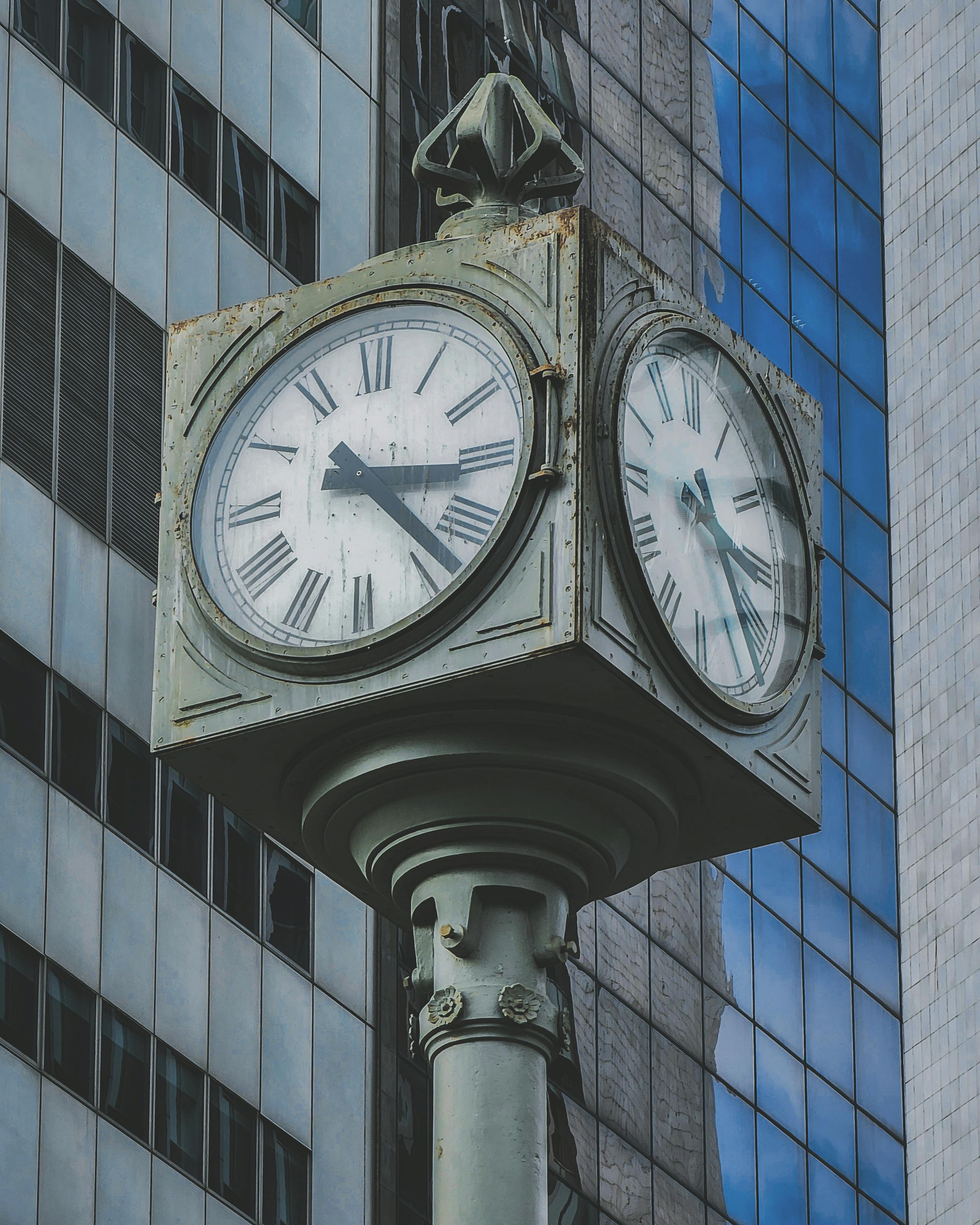 An Antique Clock Attached to a Building · Free Stock Photo
