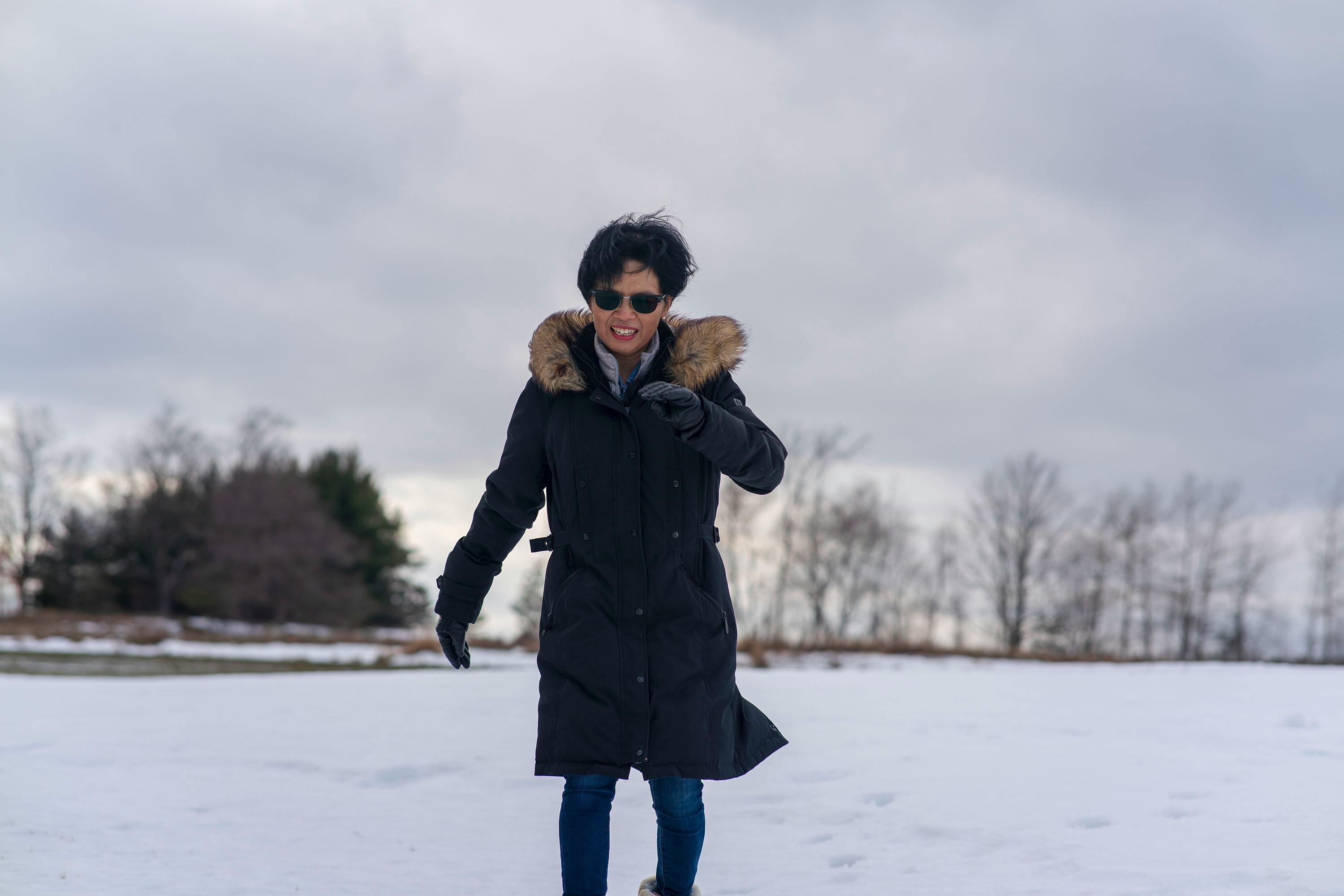 Person in Jacket under Clouds in Snow · Free Stock Photo