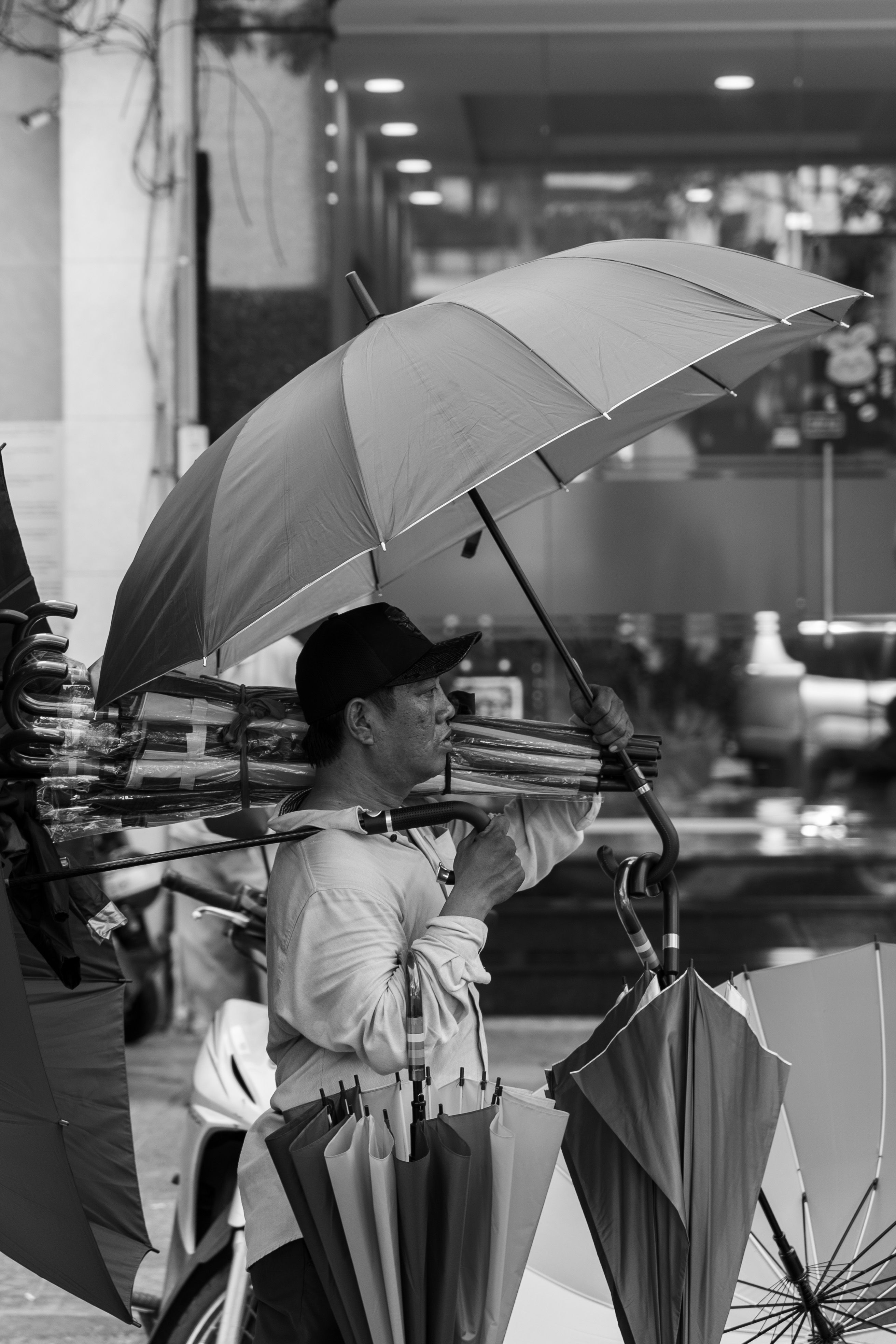 Man Carrying Umbrellas · Free Stock Photo