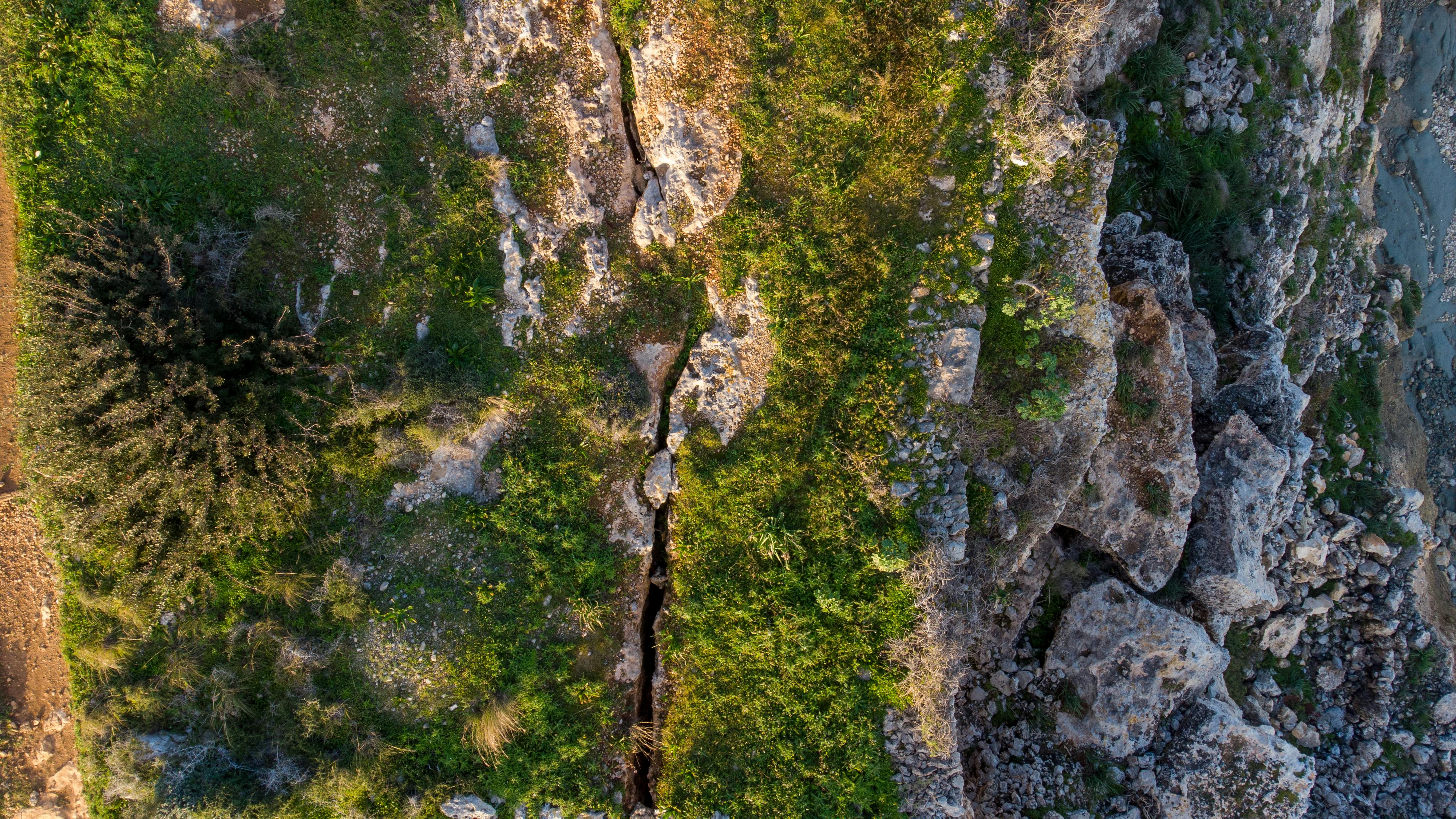 Crack in Rocky Mountains at Shore · Free Stock Photo