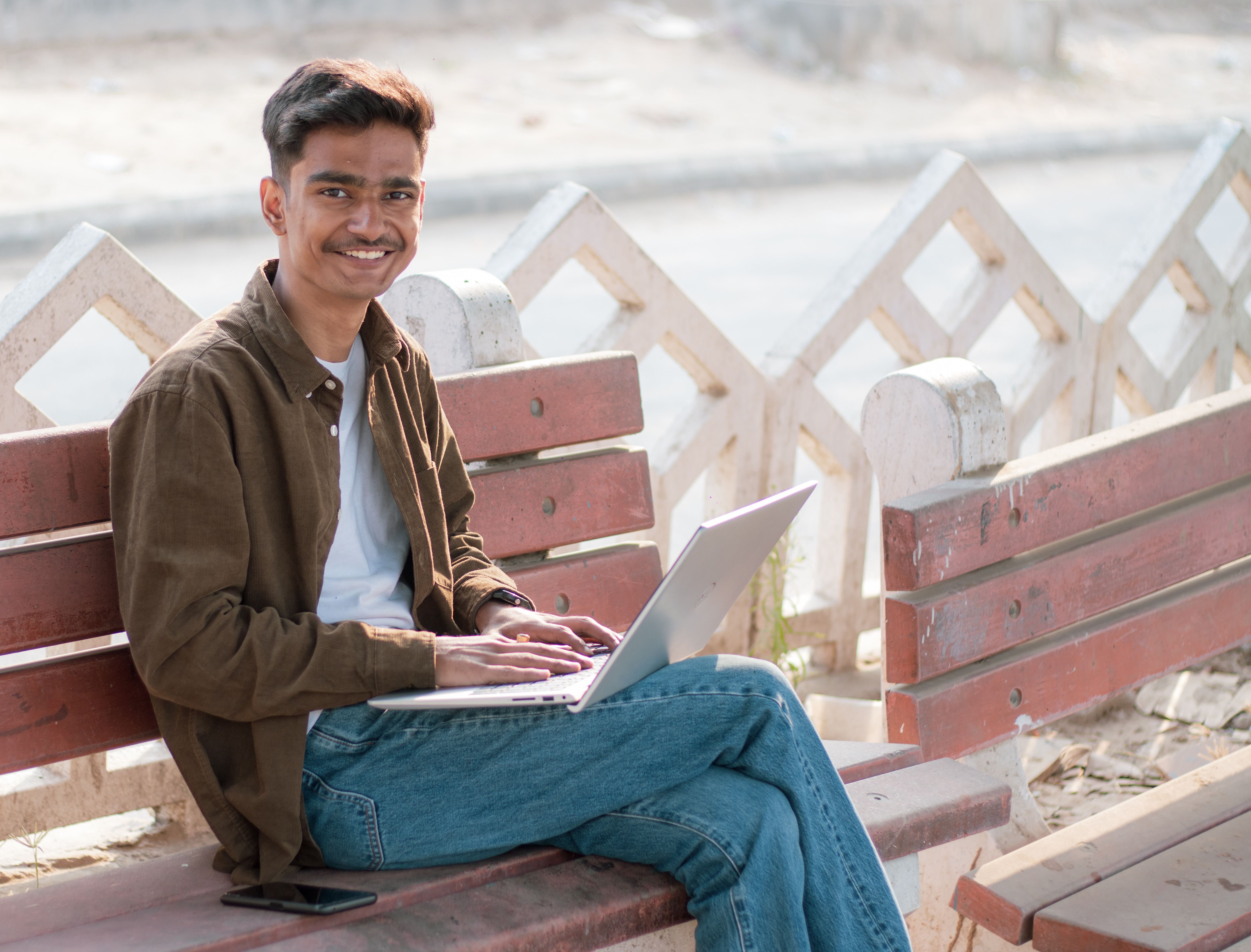 Young indian boy is doing his work in laptop. · Free Stock Photo