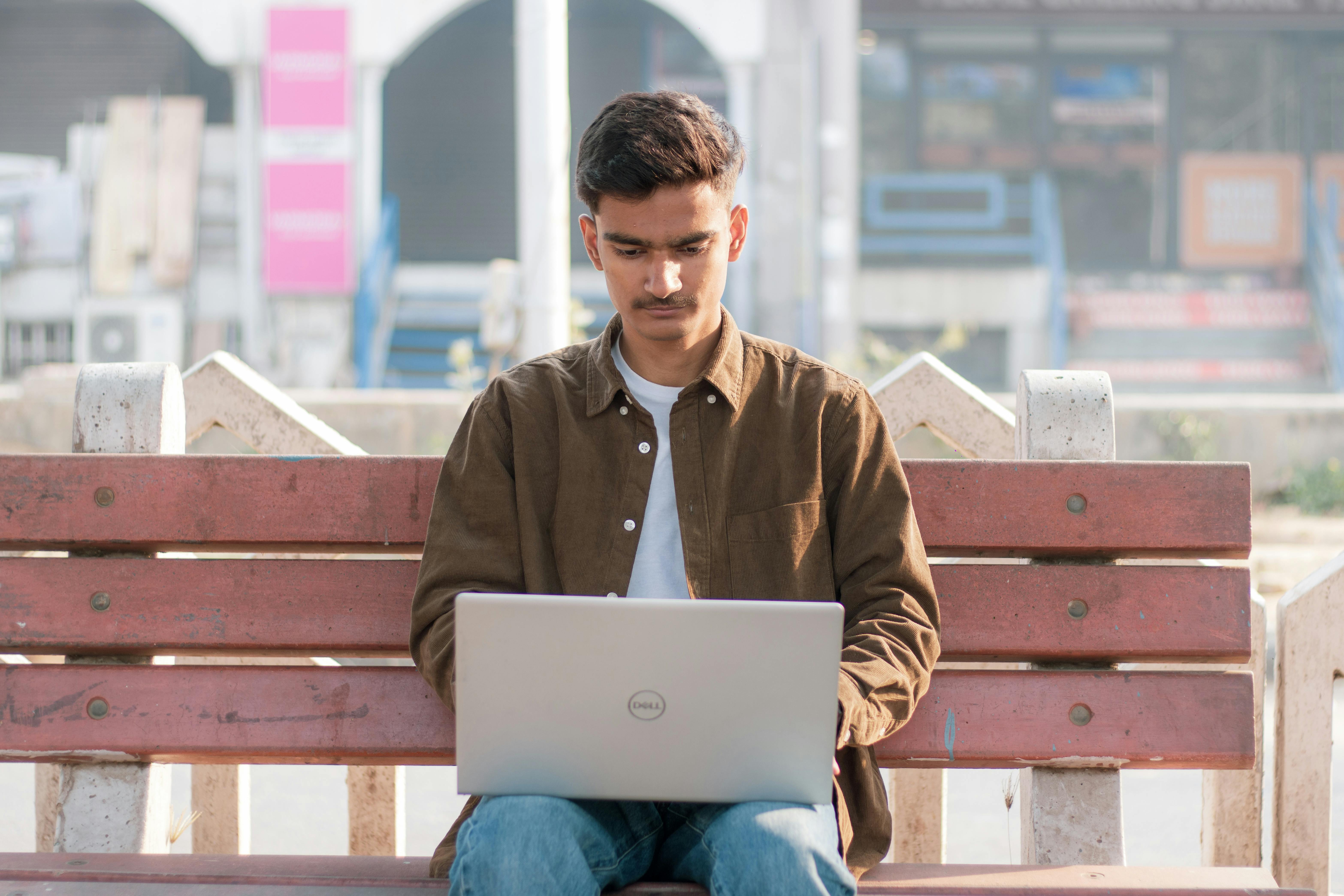 Young indian boy is doing his work in laptop. · Free Stock Photo