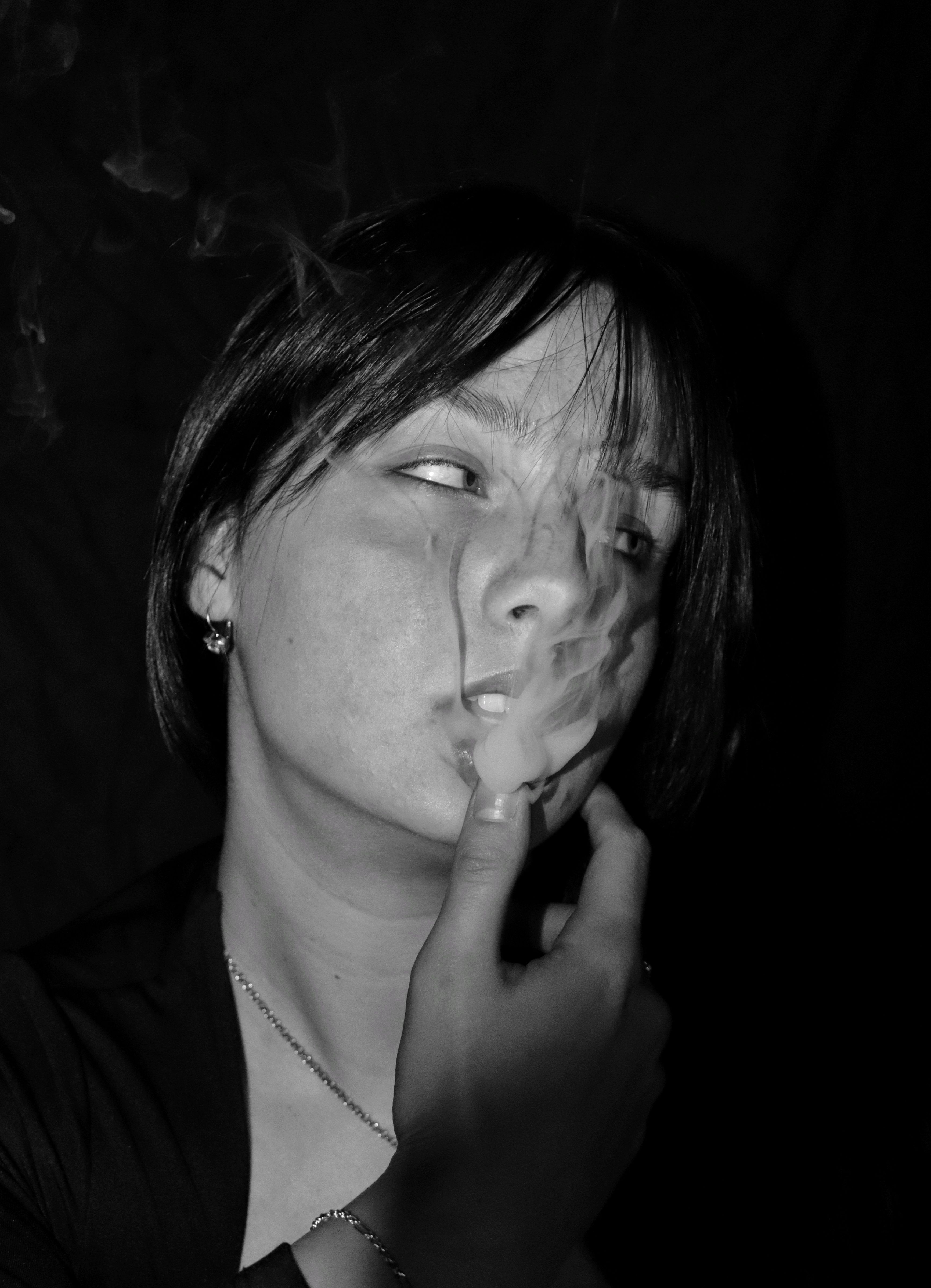 Young Woman Smoking a Cigarette · Free Stock Photo