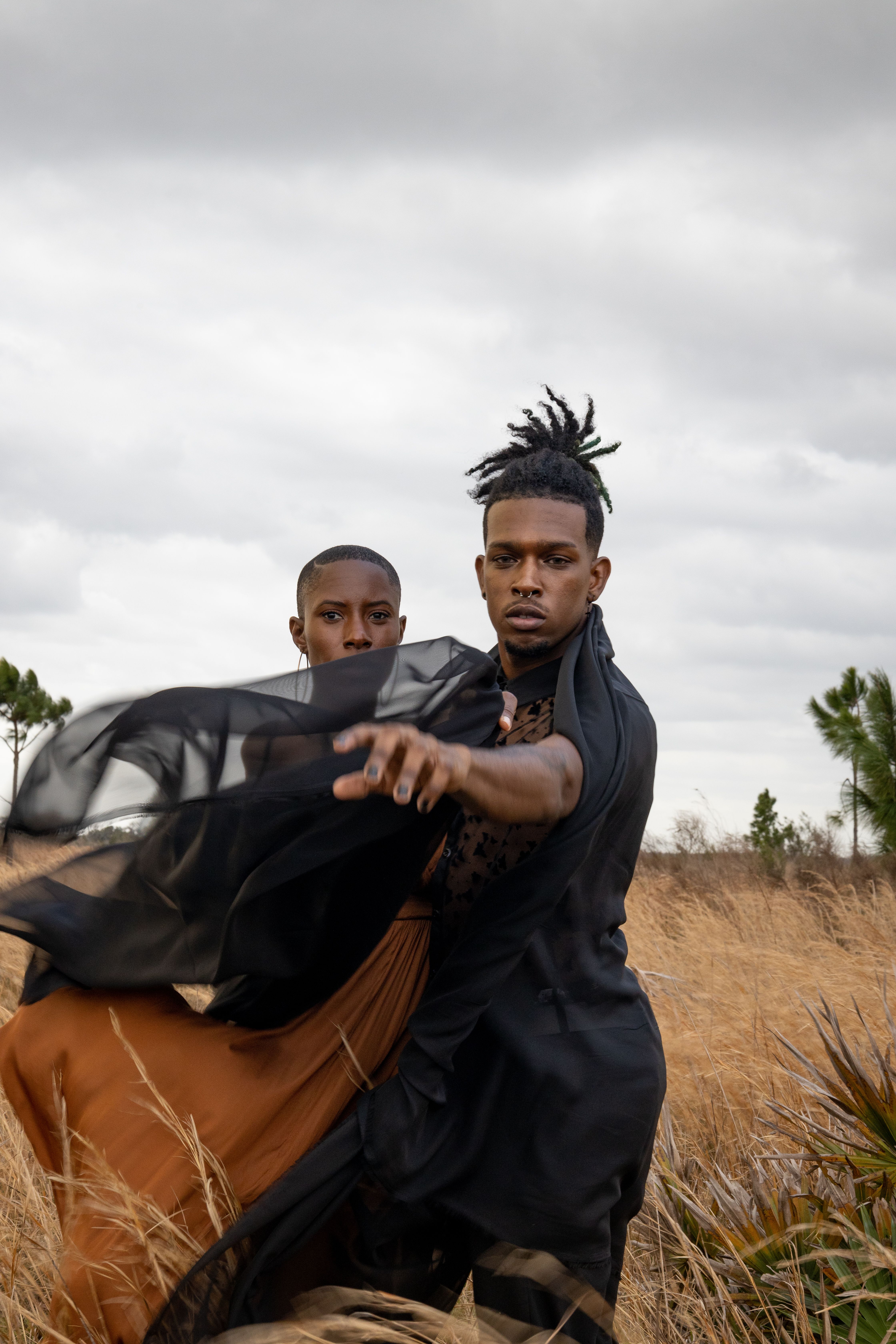 Two men in black clothing standing in a field · Free Stock Photo