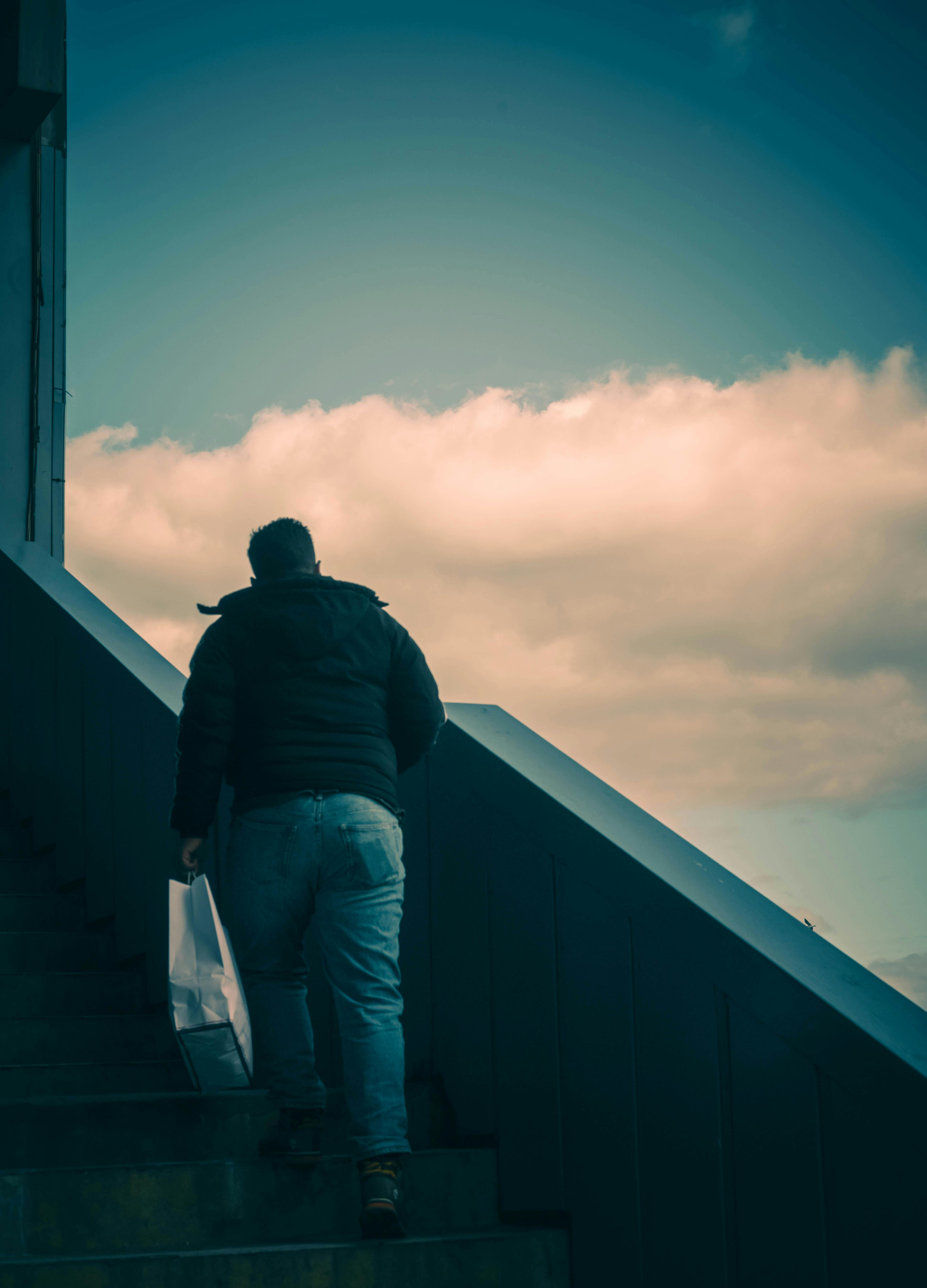 Man walking down the old stone staircase · Free Stock Photo