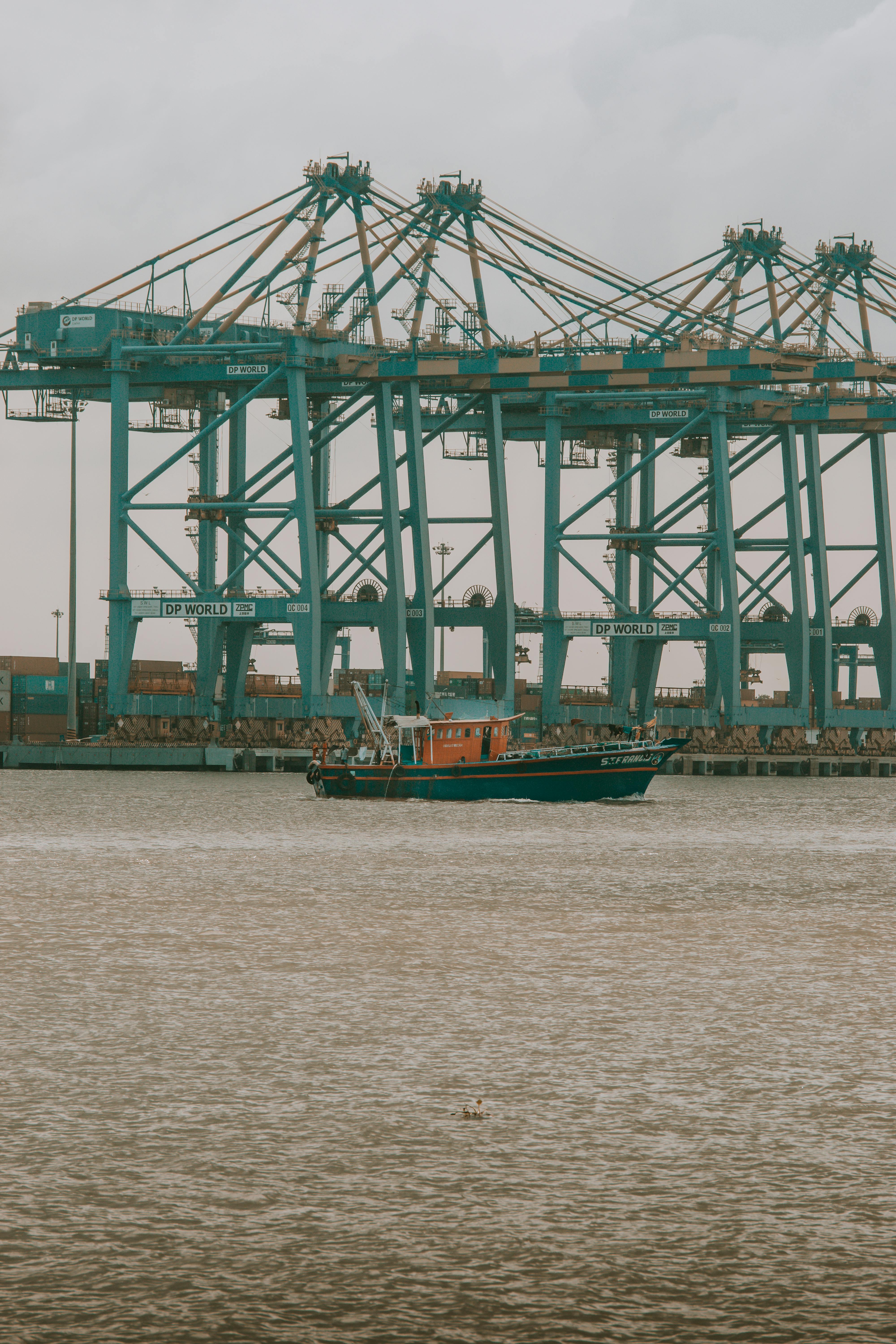 Red Concrete Building Near the Ocean With Boat during Daytime · Free ...