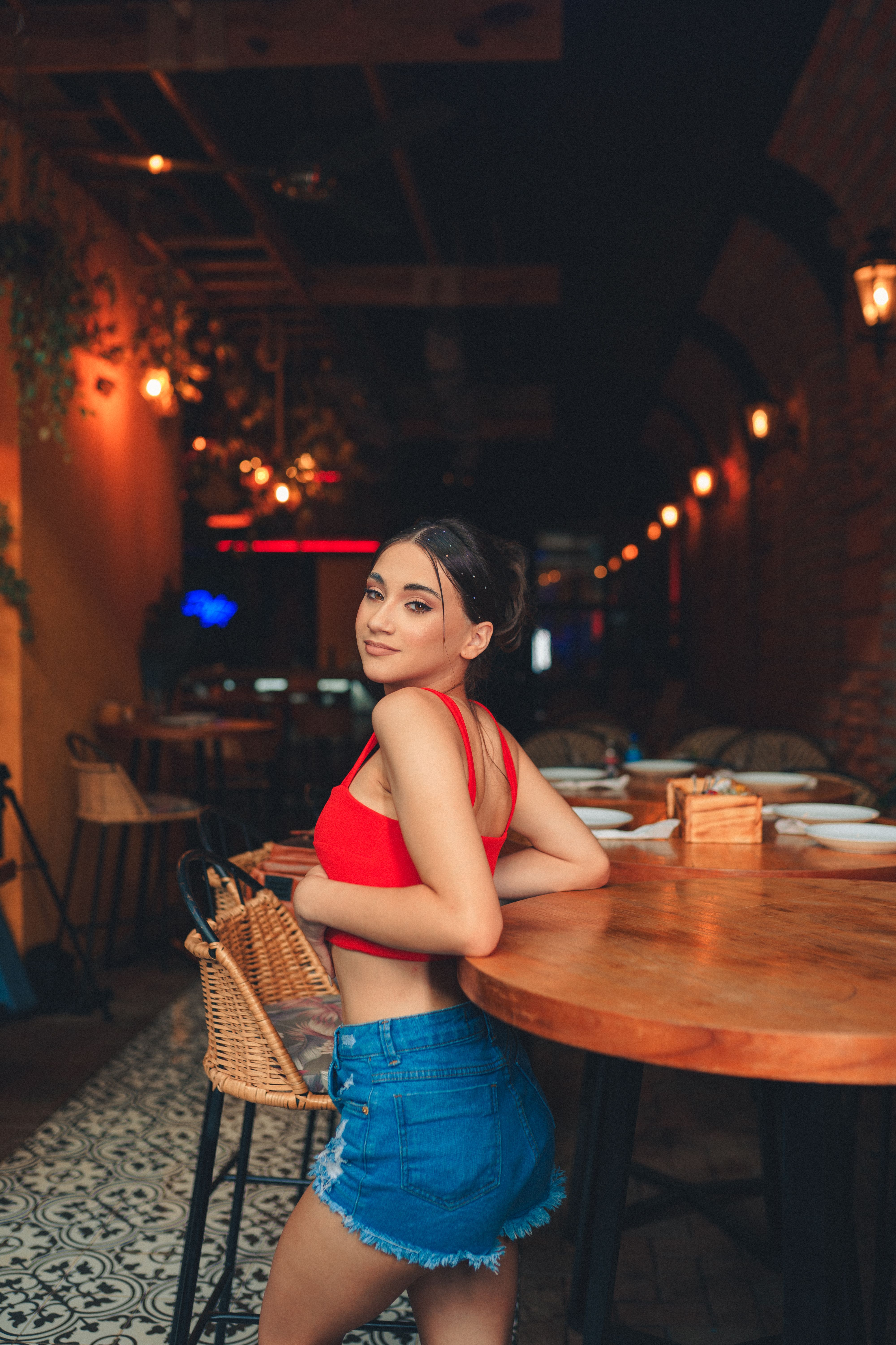 Young Woman Standing by a Table in a Restaurant · Free Stock Photo