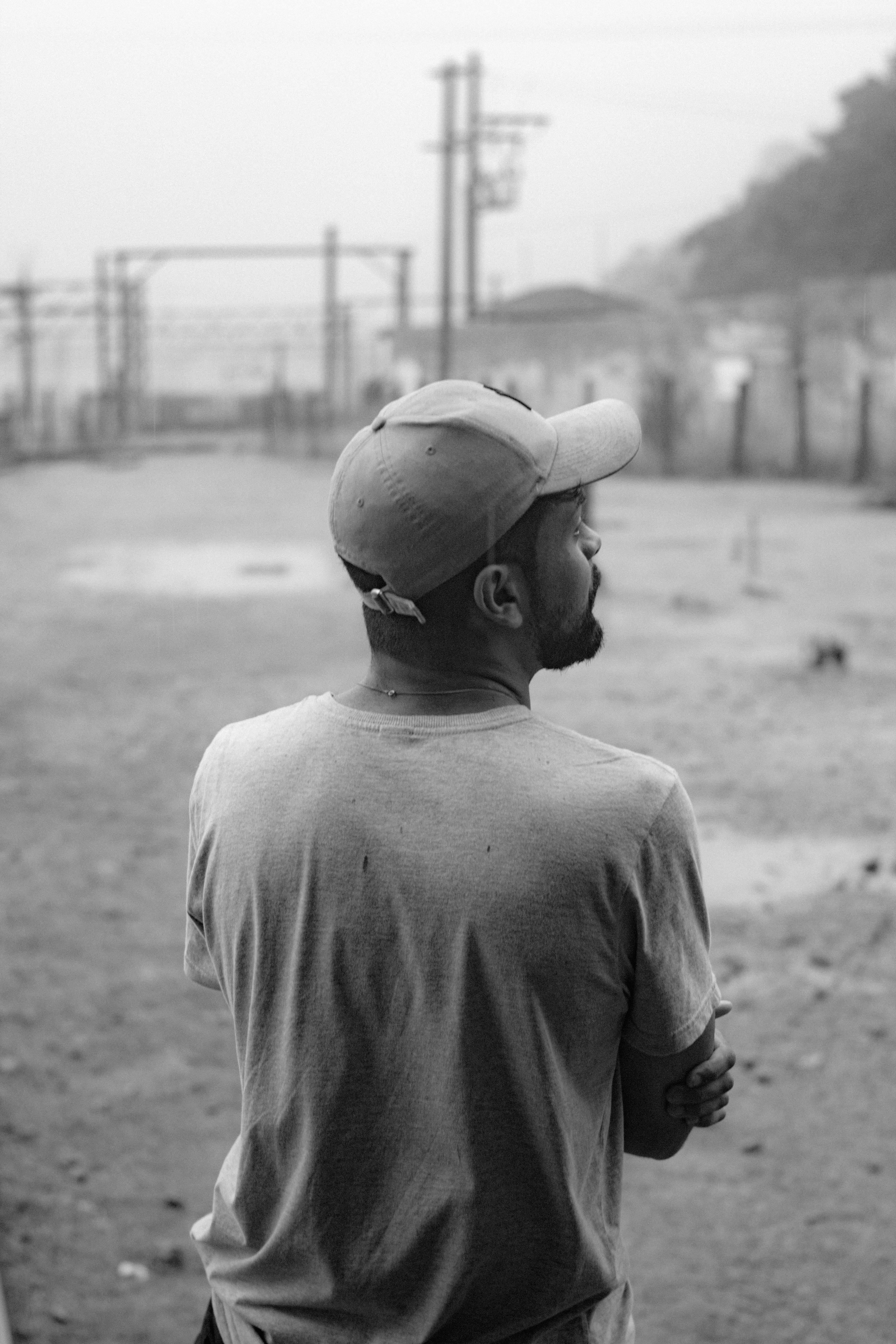Back View of Black Man in Baseball Hat and T-Shirt · Free Stock Photo