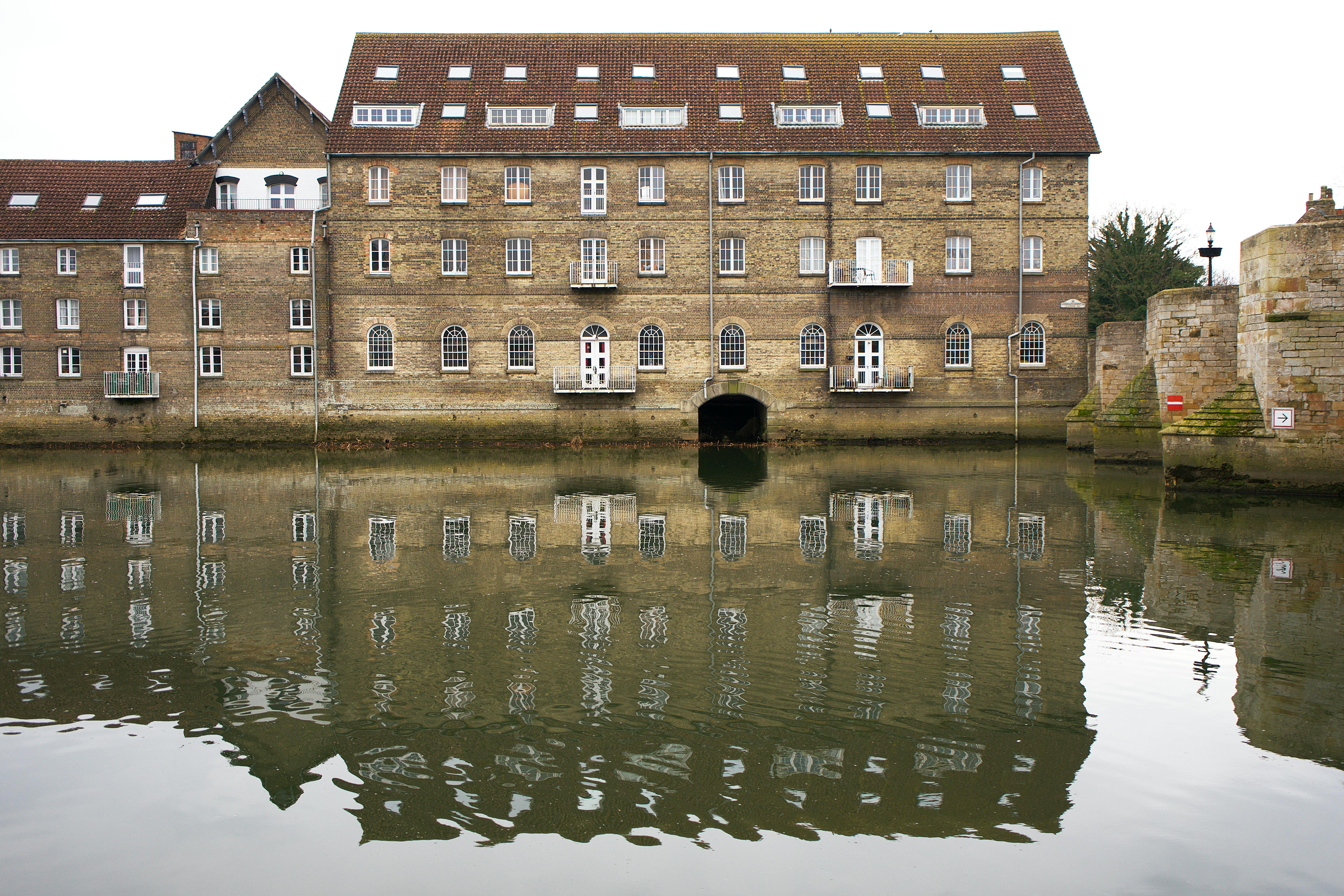 Vintage Building by River · Free Stock Photo