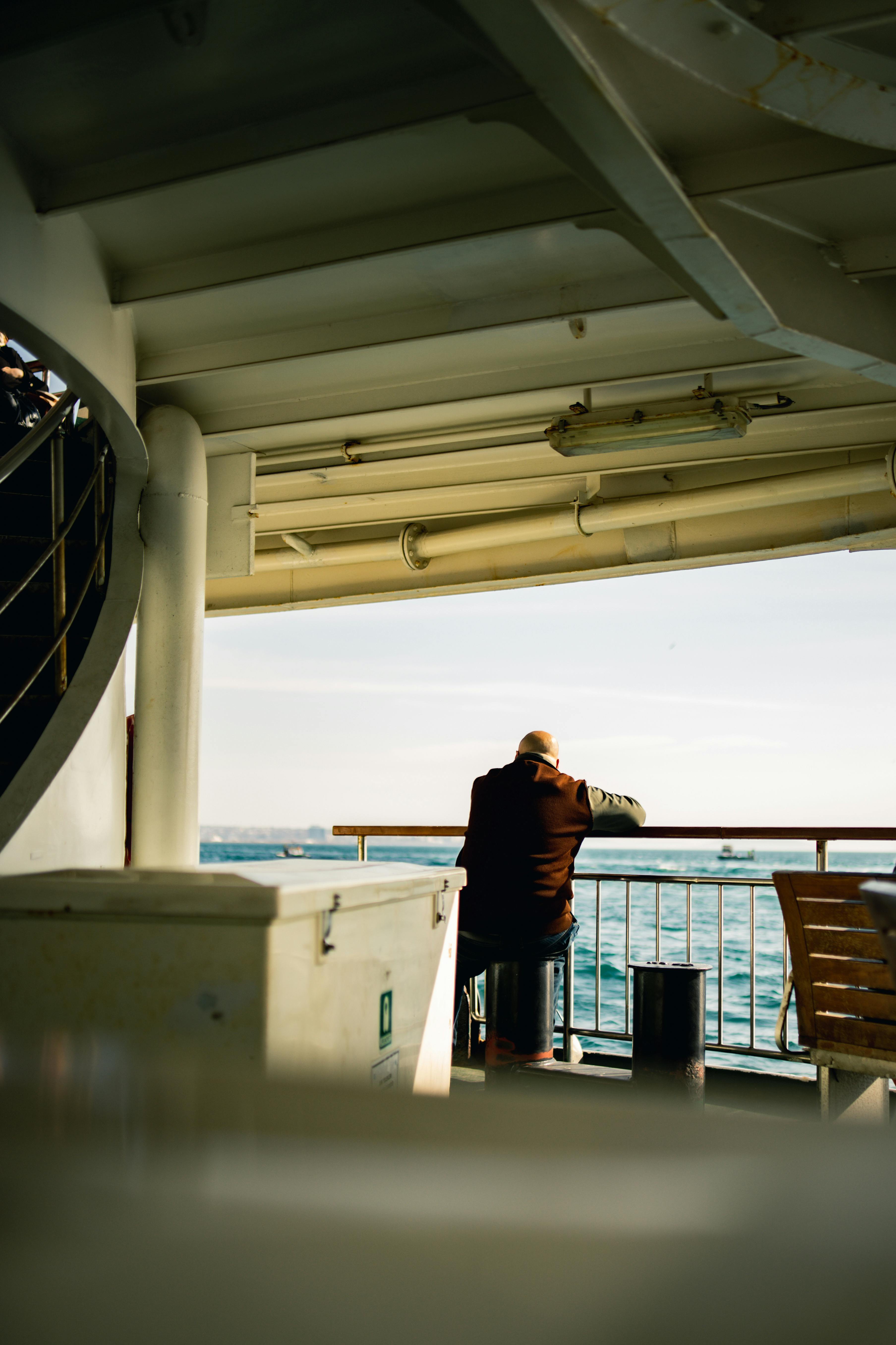 Man Leaning on Ferry Handrail · Free Stock Photo