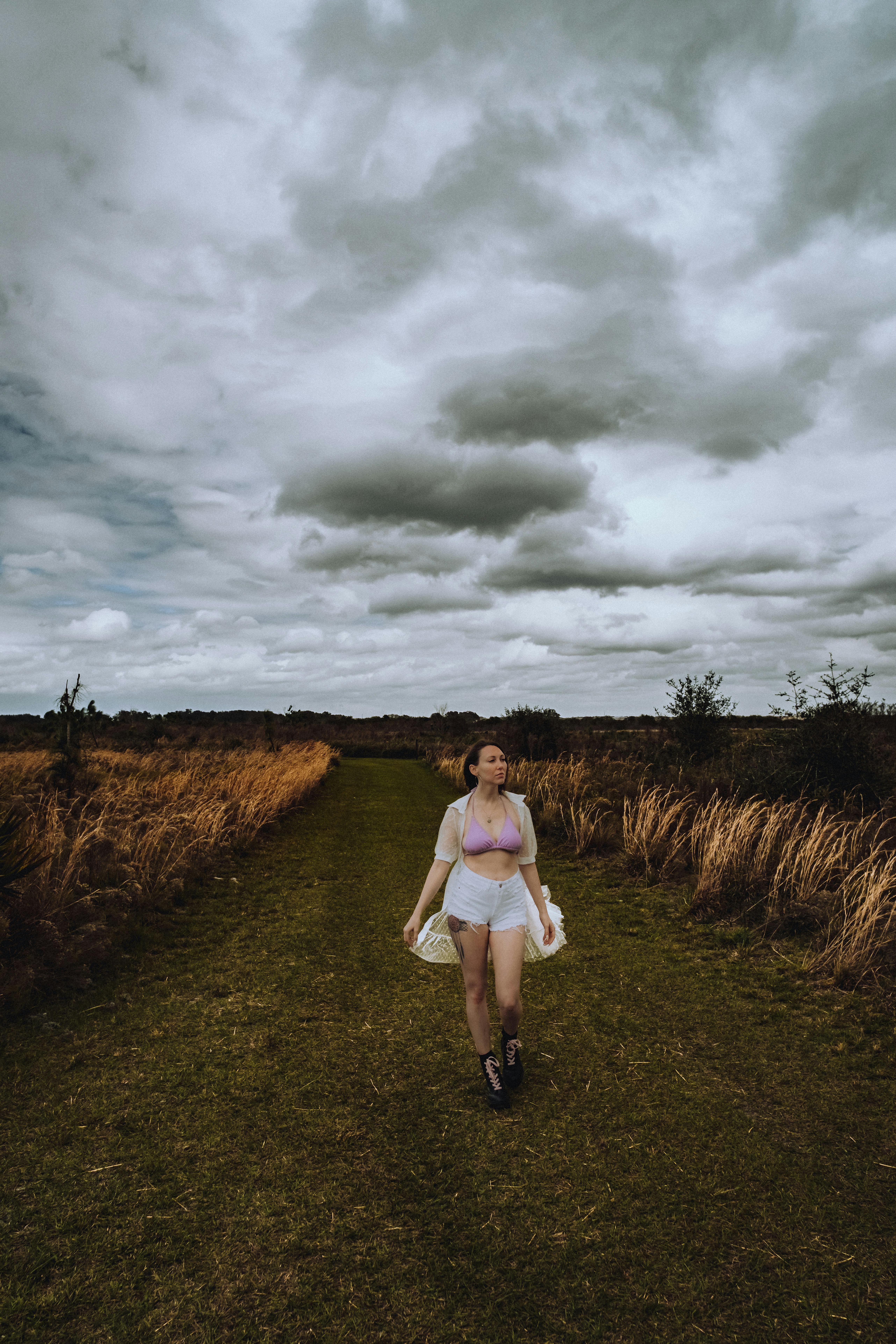 Woman Wearing Bikini on a Cloudy Field · Free Stock Photo