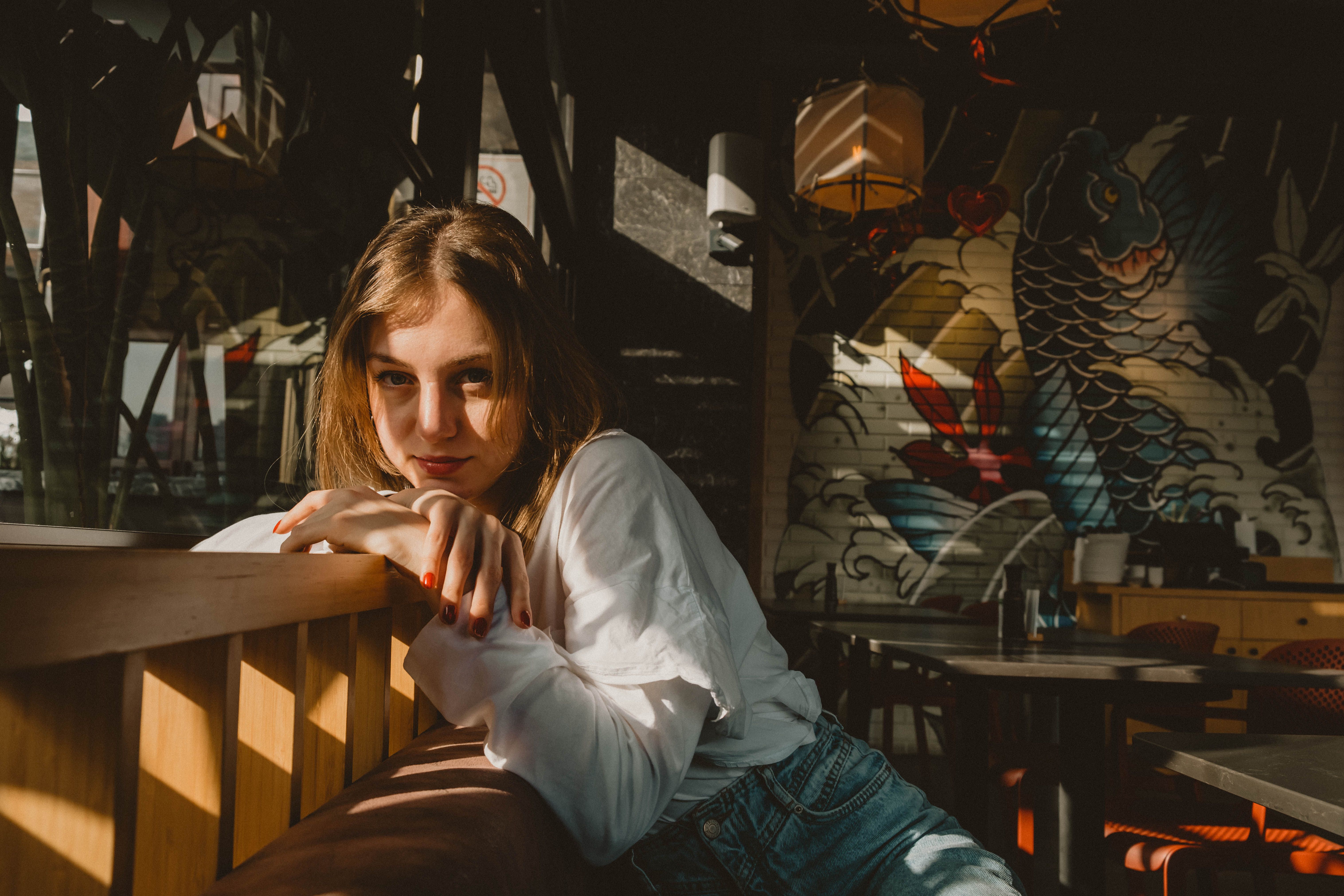 Girl Sitting in a Cafeteria · Free Stock Photo