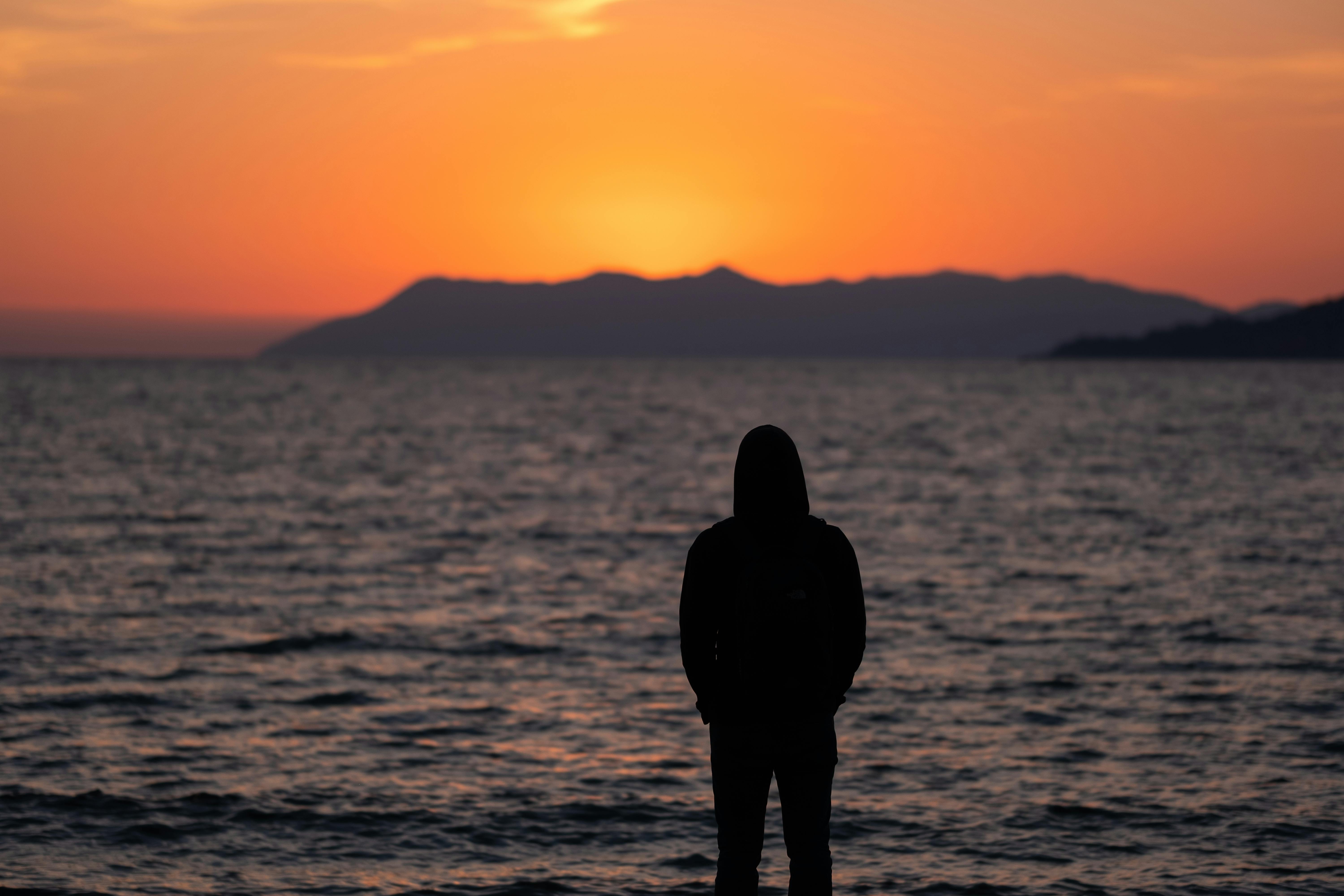 Woman in a Dress Walking into the Sea · Free Stock Photo