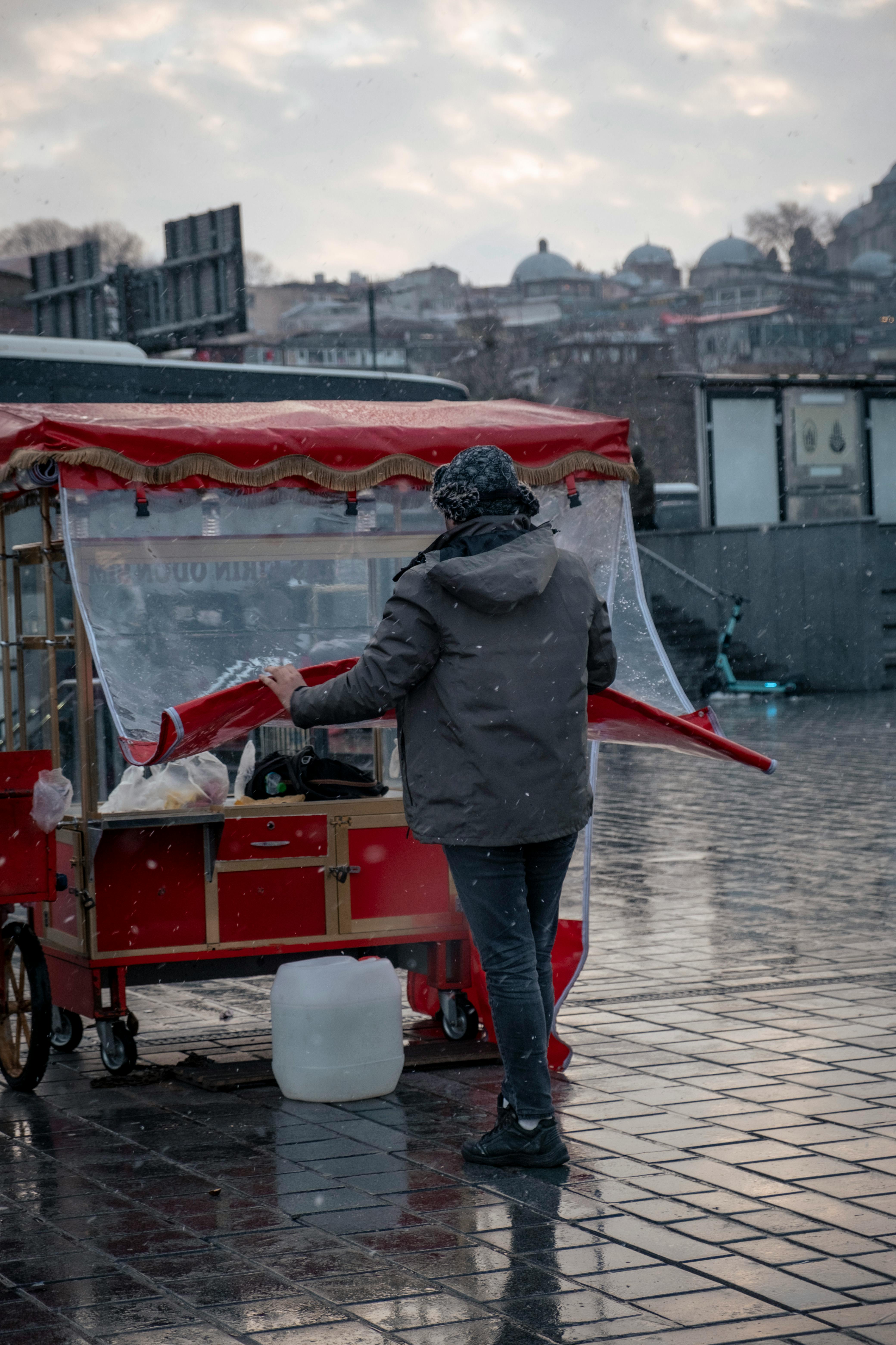 A Man Selling Food in the Rain · Free Stock Photo