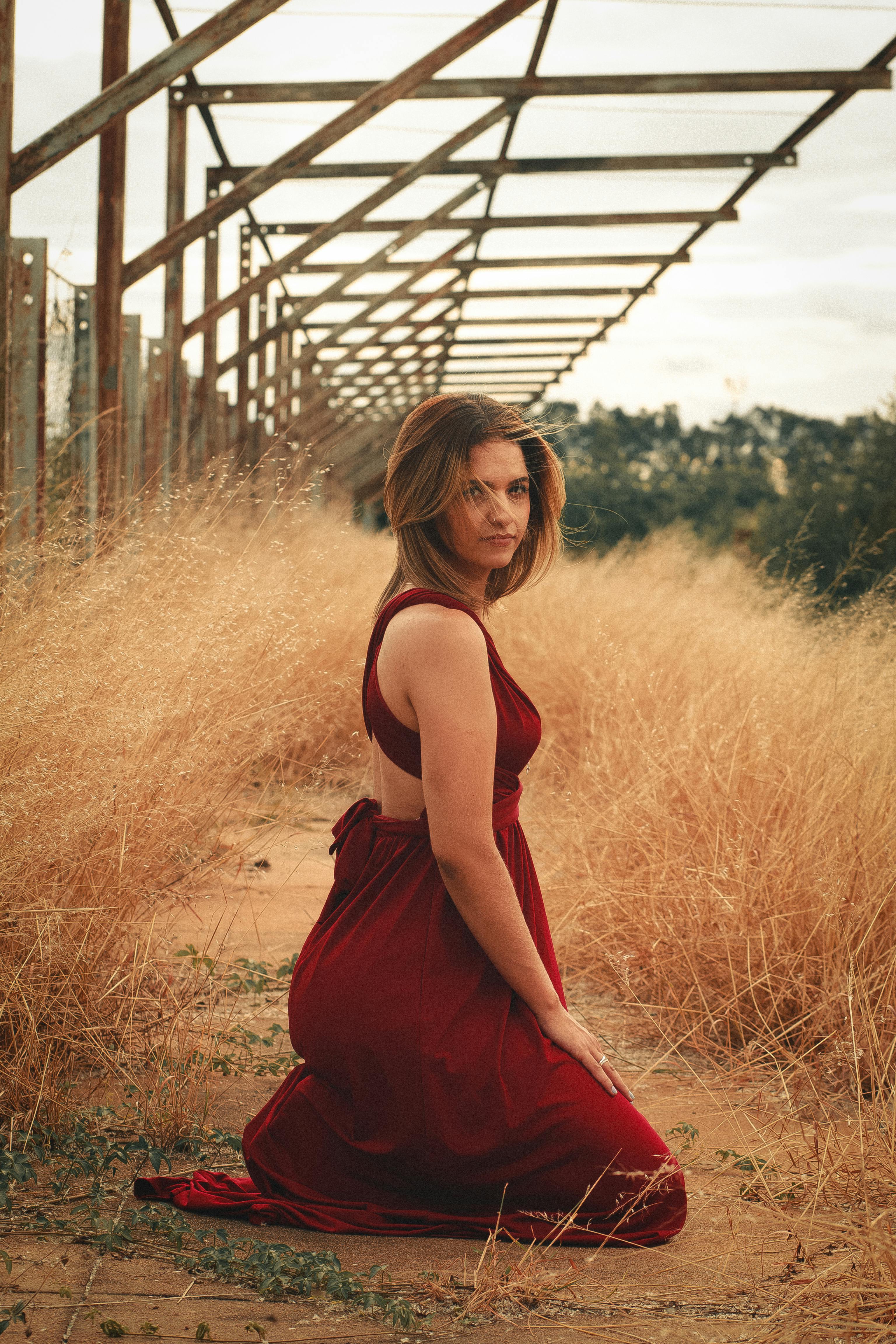 Woman Kneeling in Red Dress · Free Stock Photo