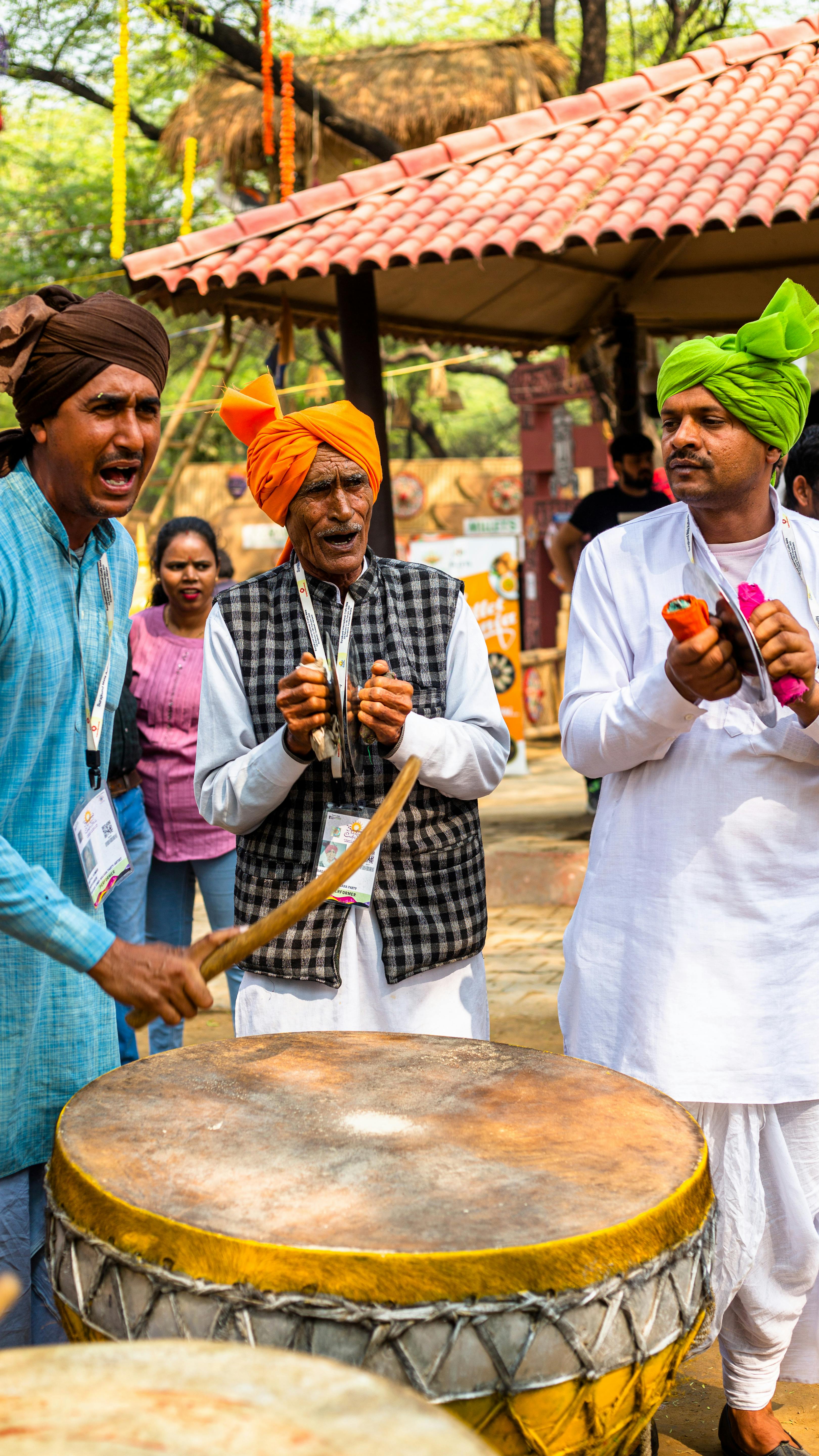 Three Men Playing Drums and Cymbals Outdoors · Free Stock Photo