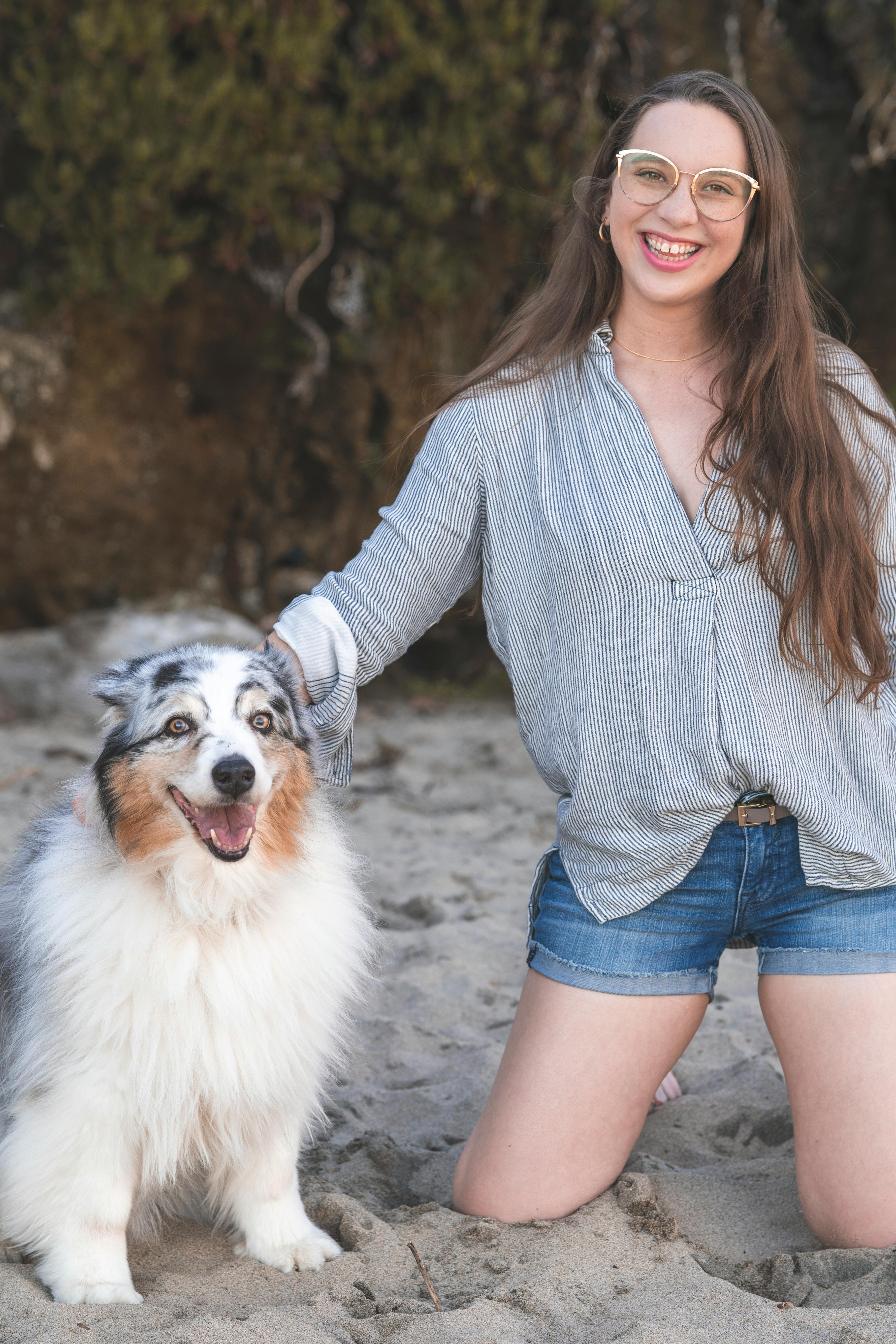 Woman Posing on Beach with Australian Shep · Free Stock Photo