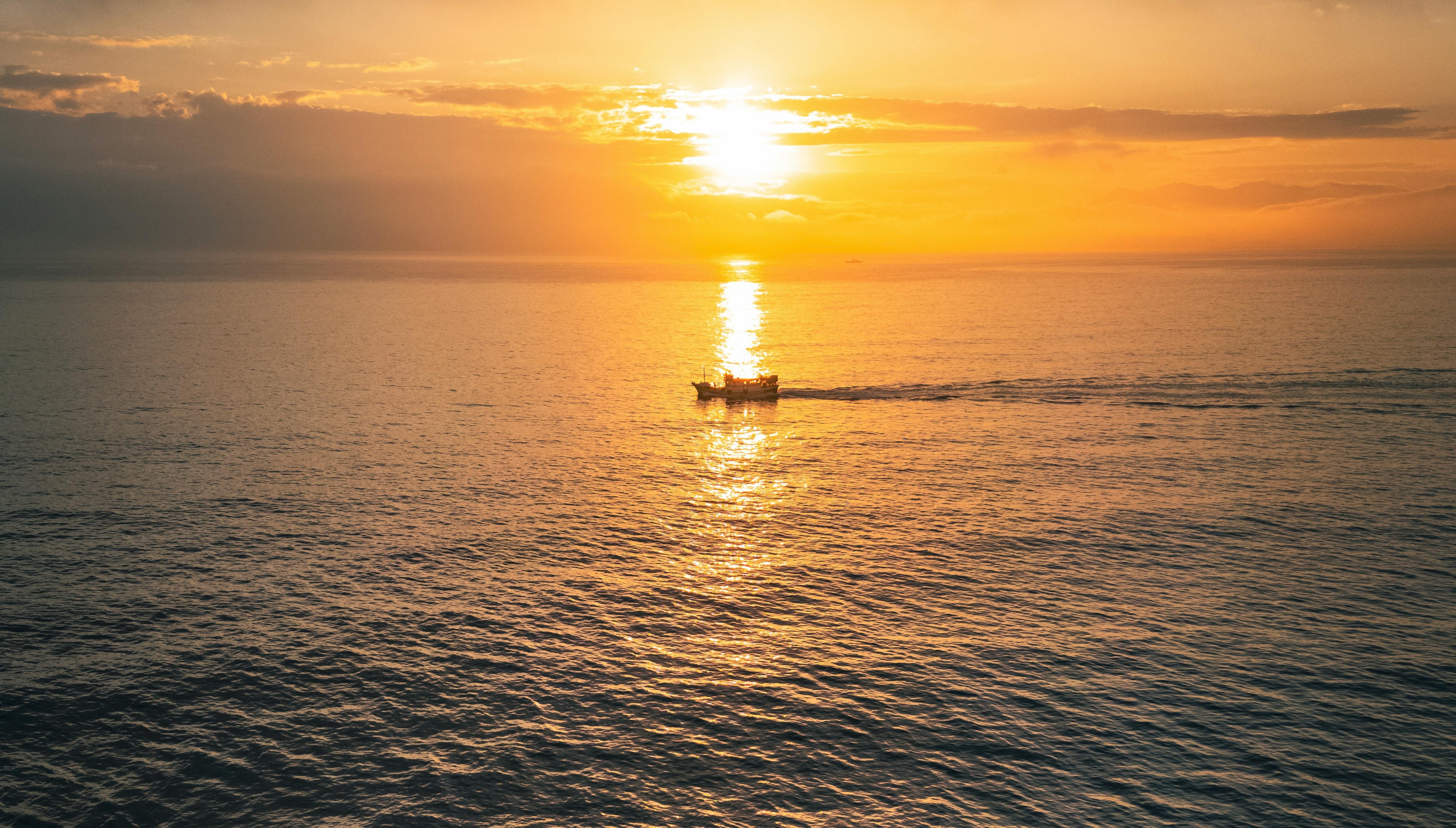 Aerial View of a Ship on the Sea at Sunset · Free Stock Photo