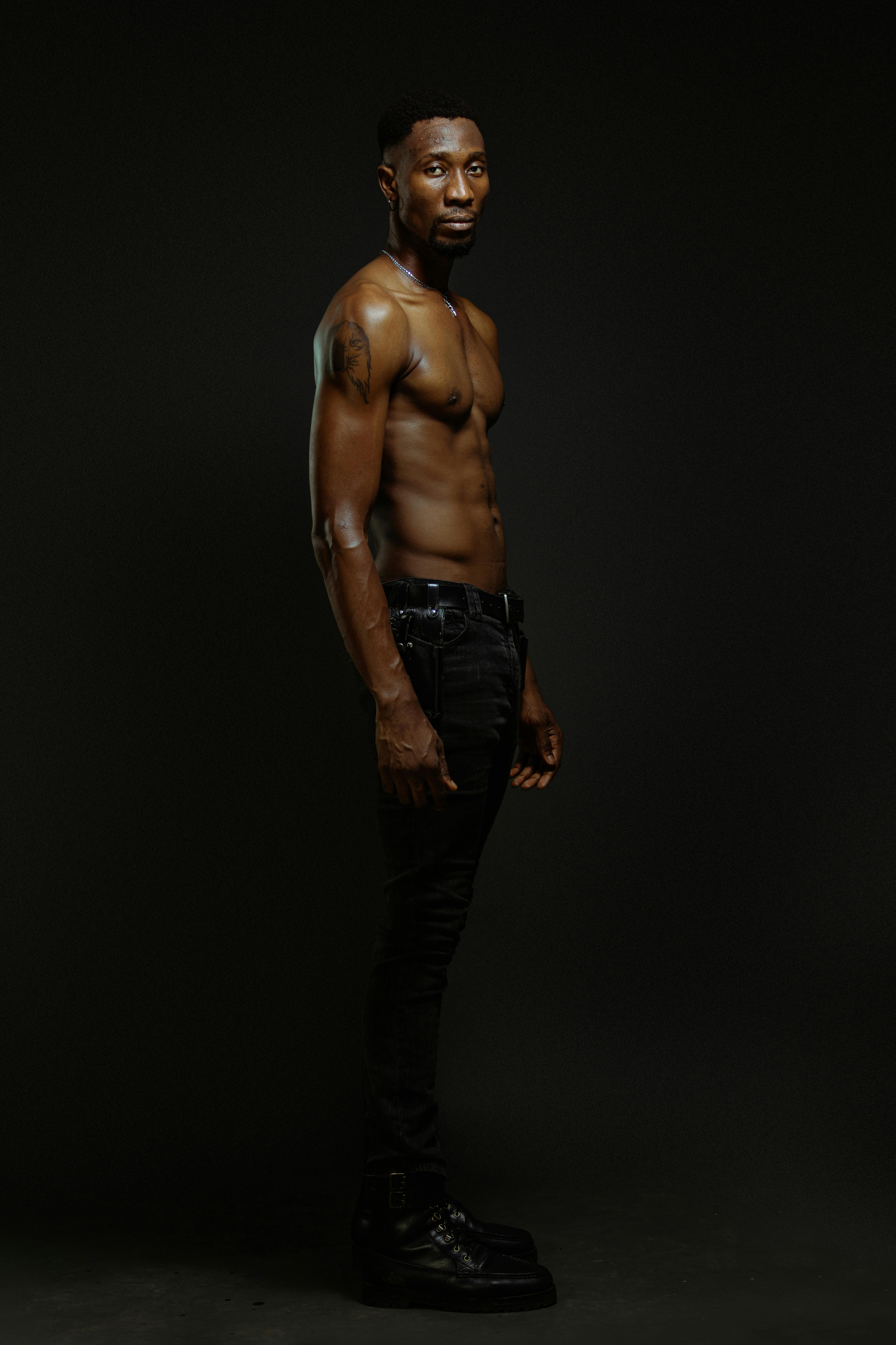 Photo of a Shirtless Young Man Showing His Middle Finger · Free Stock Photo